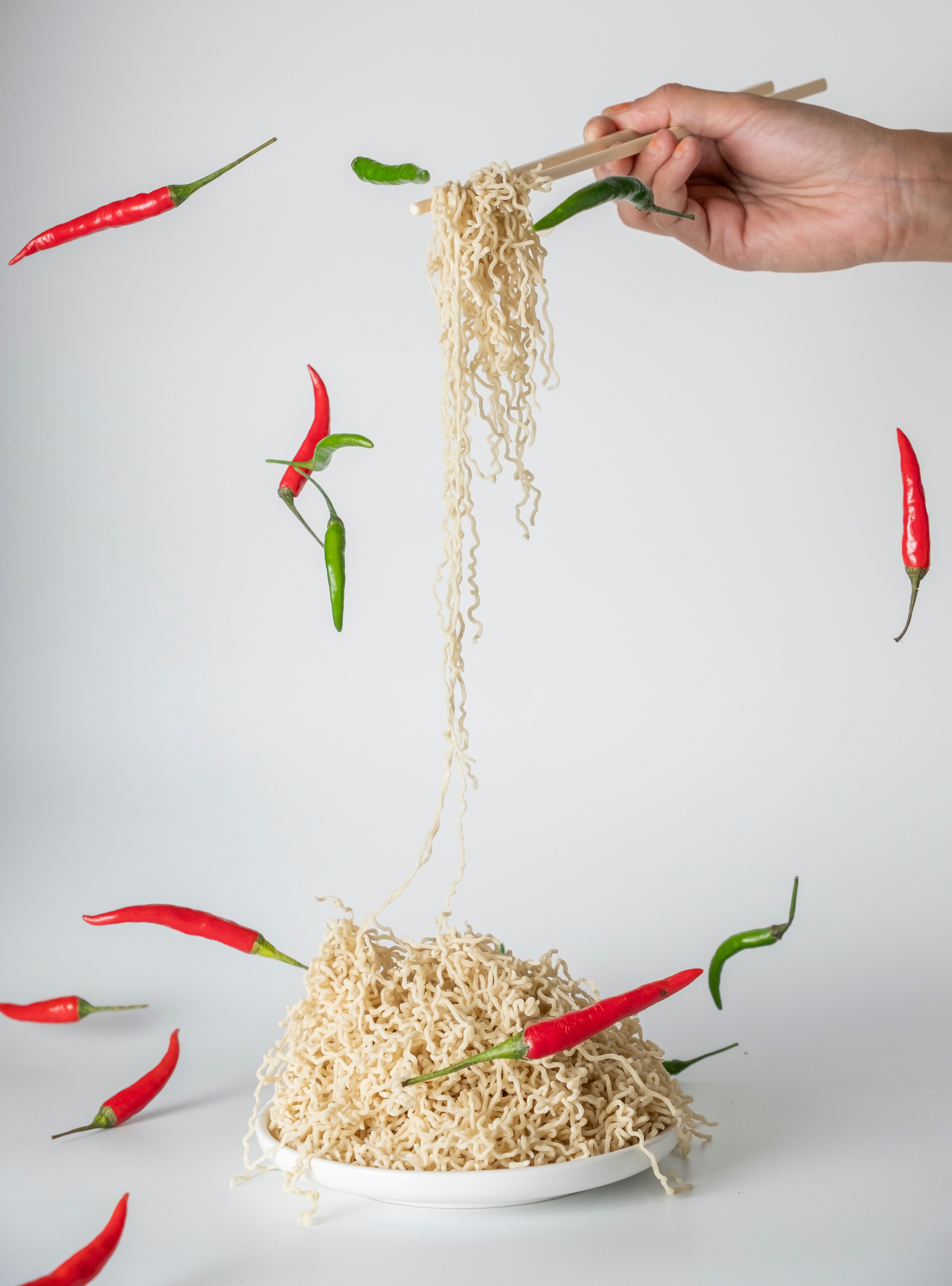 Man Eating Pasta with Chili Peppers · Free Stock Photo