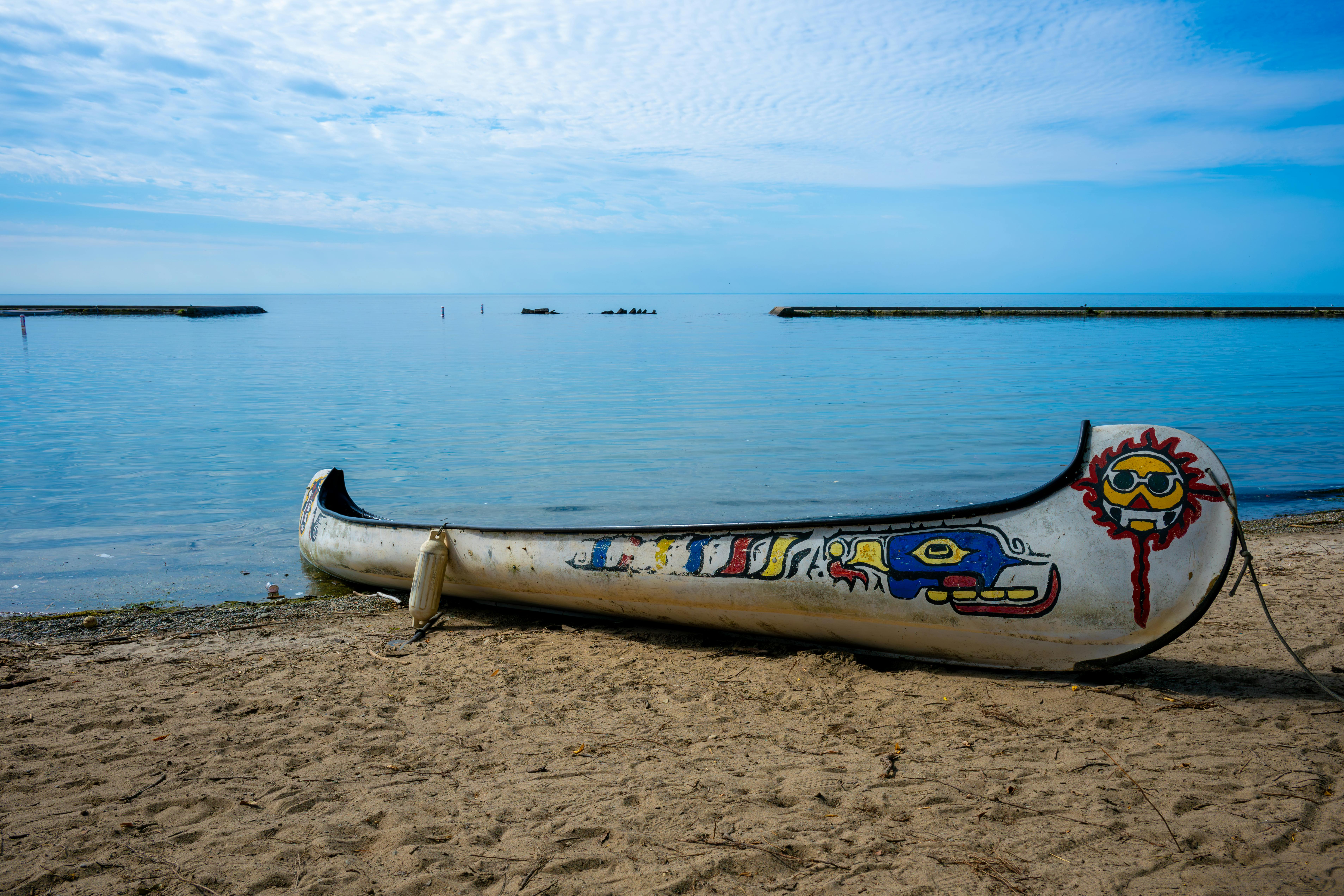 Painted Canoe on Beach · Free Stock Photo