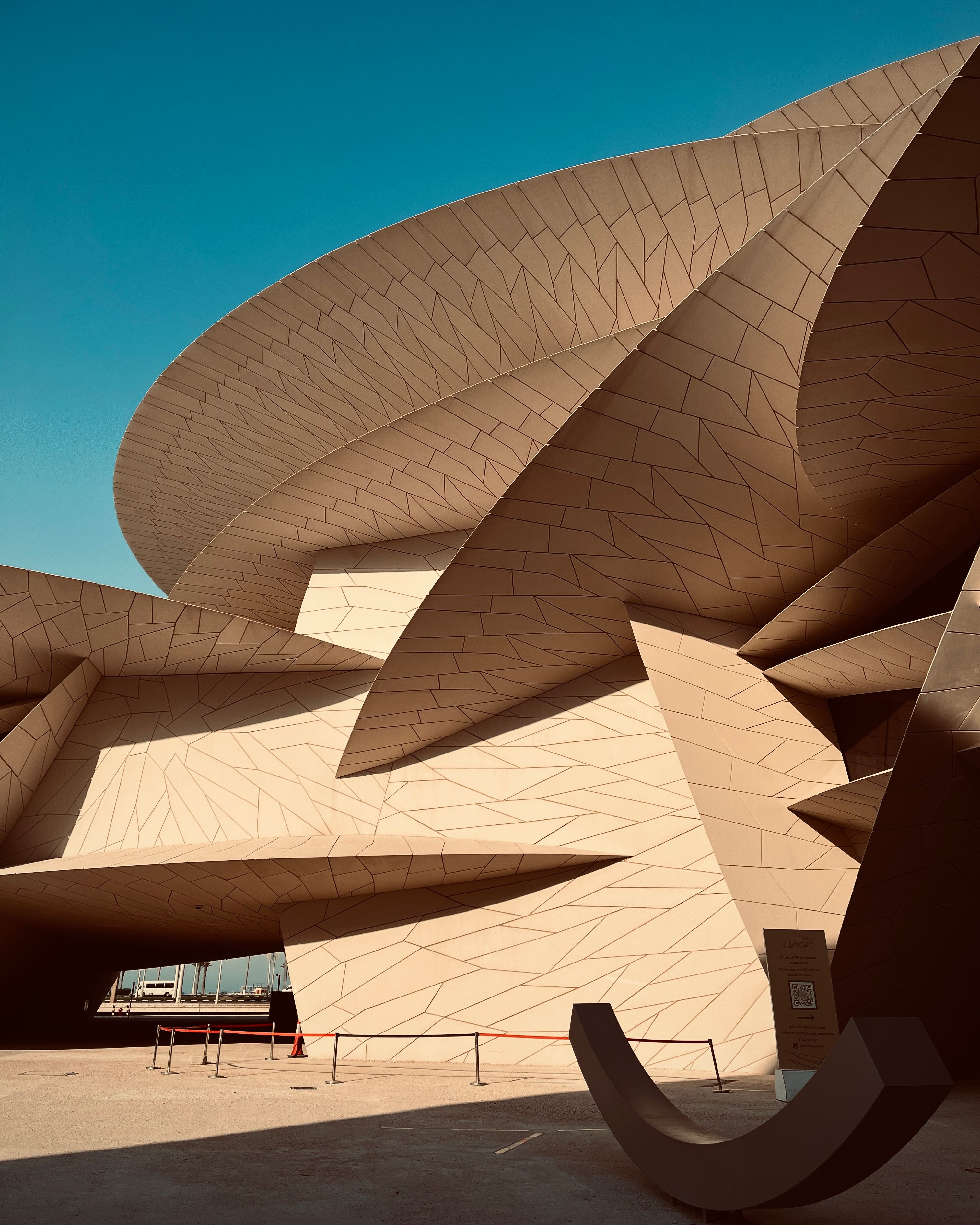 The building is made of curved shapes and has a large curved roof ...