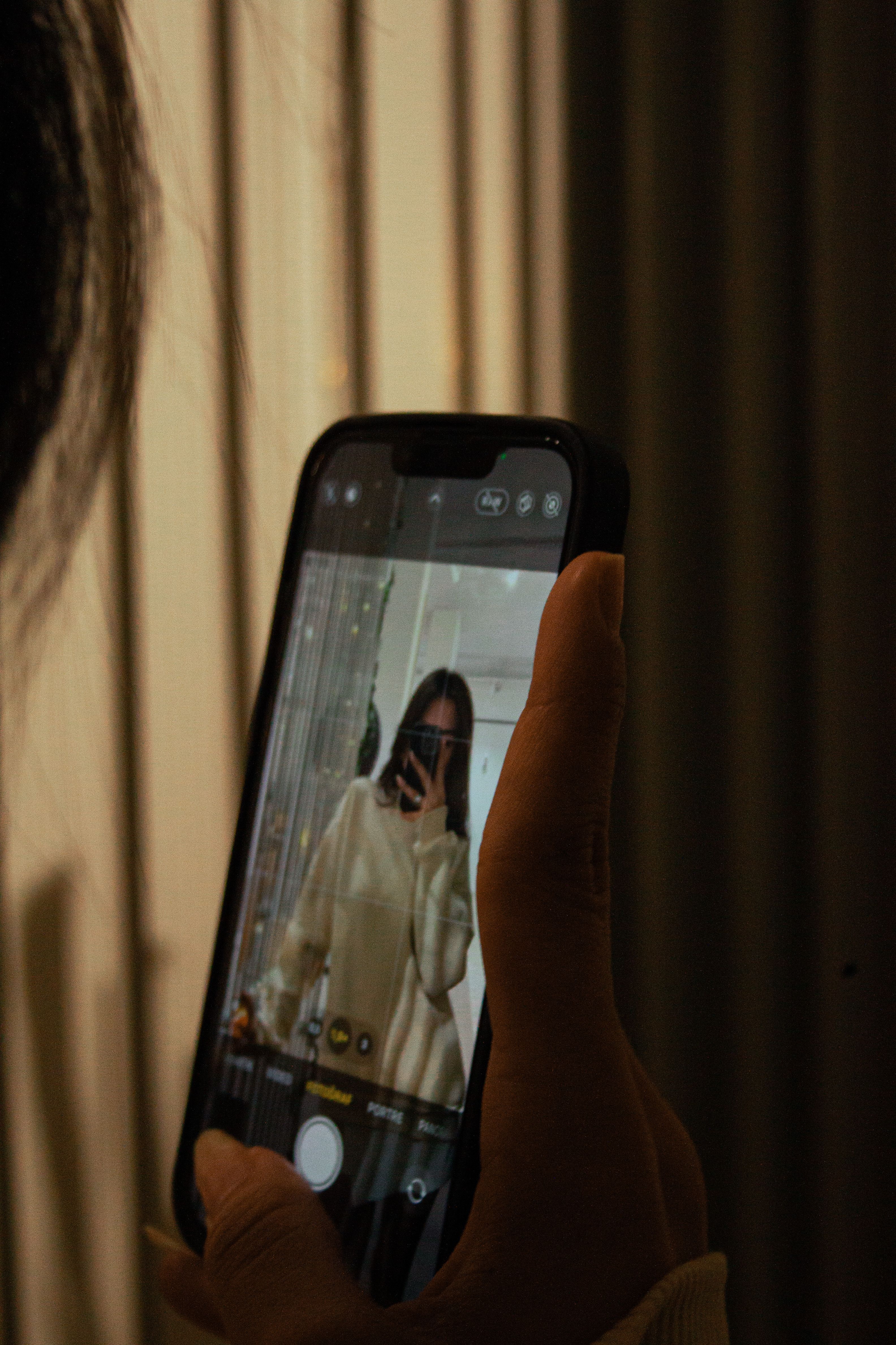 A person holding up a cell phone with a picture of a woman · Free Stock ...