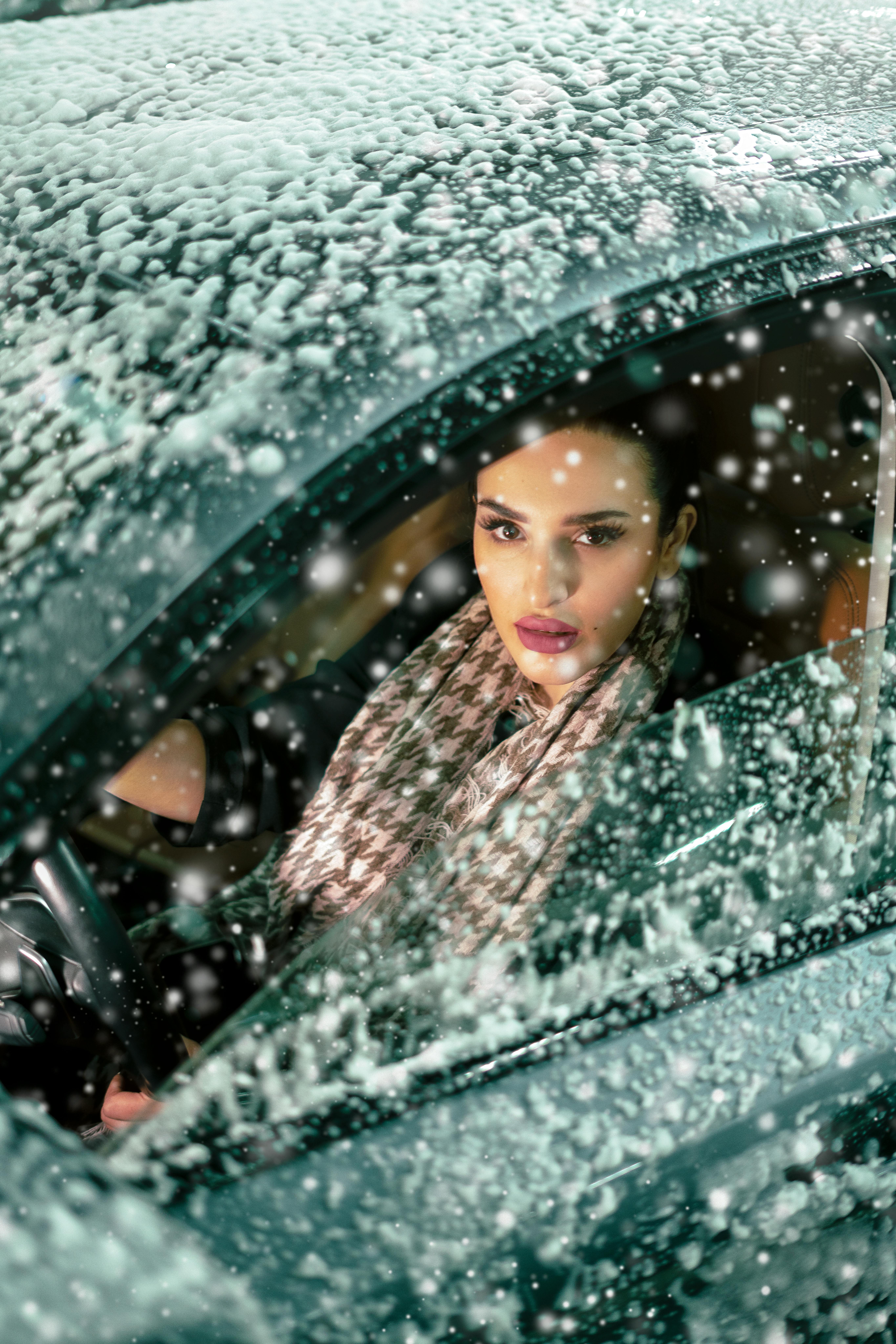 Portrait of Woman behind Car Window in Snow · Free Stock Photo