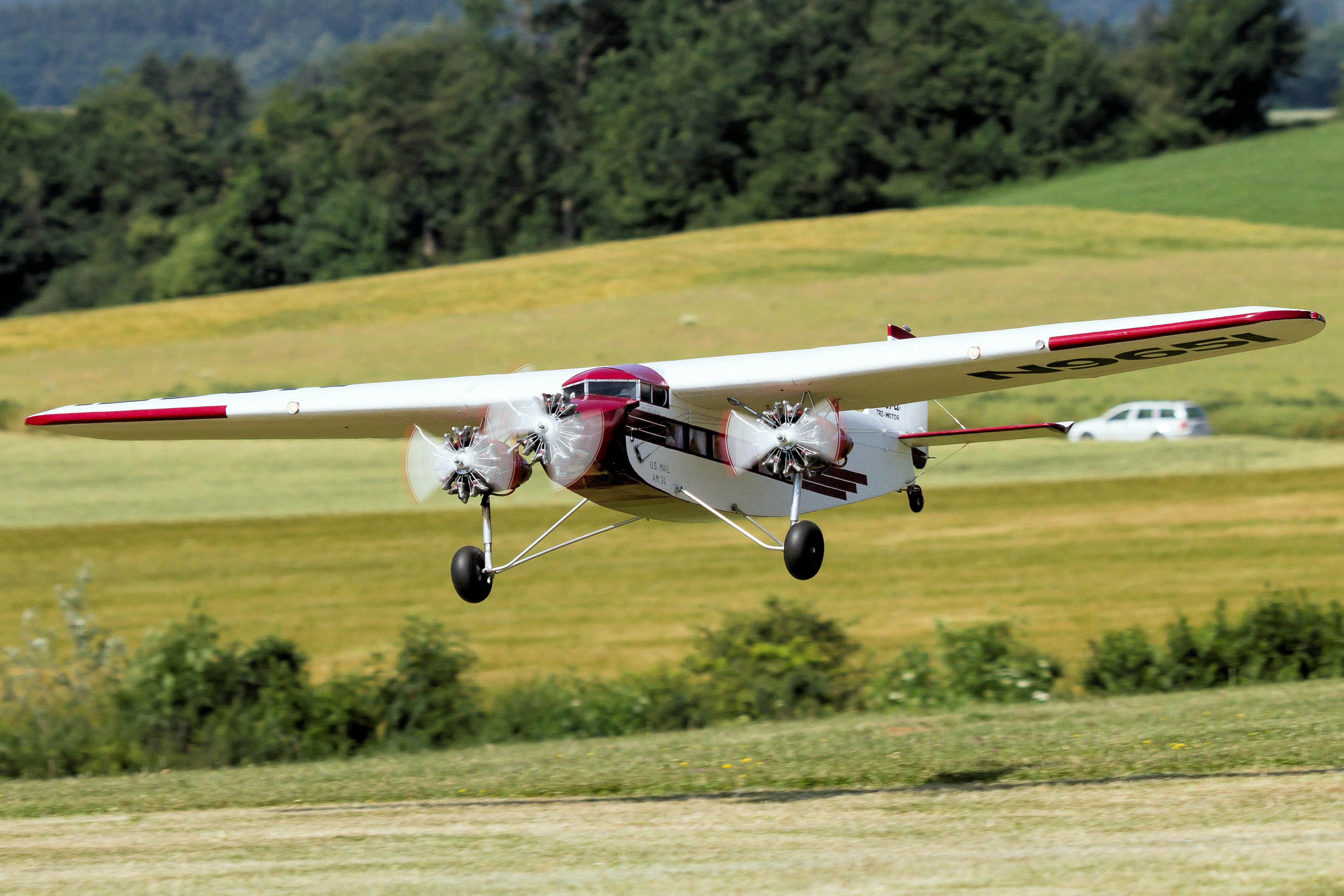 An Airplane Model Flying Above a Field · Free Stock Photo