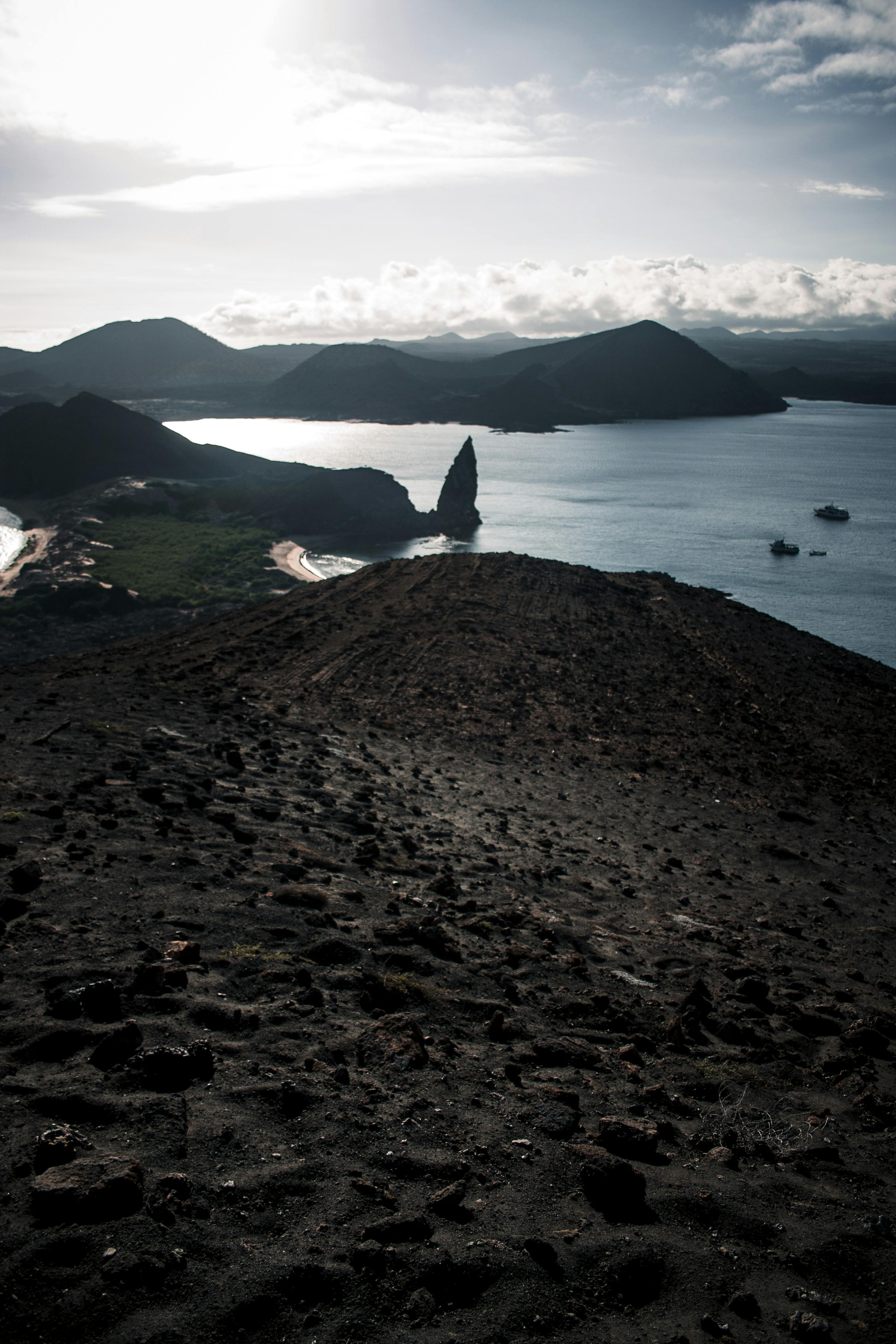 Galapagos Pinnacle Rock and Volcanic Shoreline · Free Stock Photo