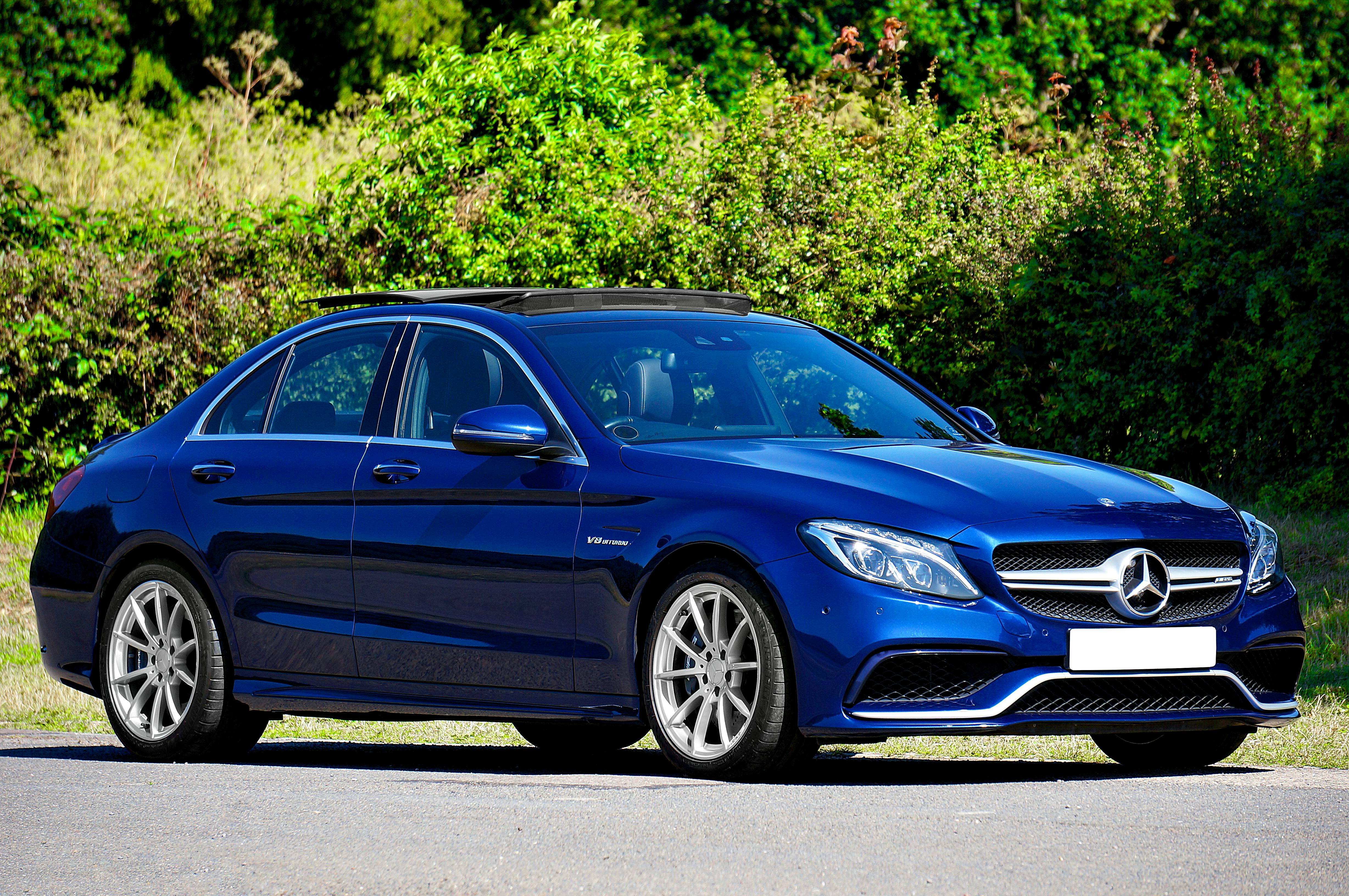 Blue Car Parked near Bushes · Free Stock Photo