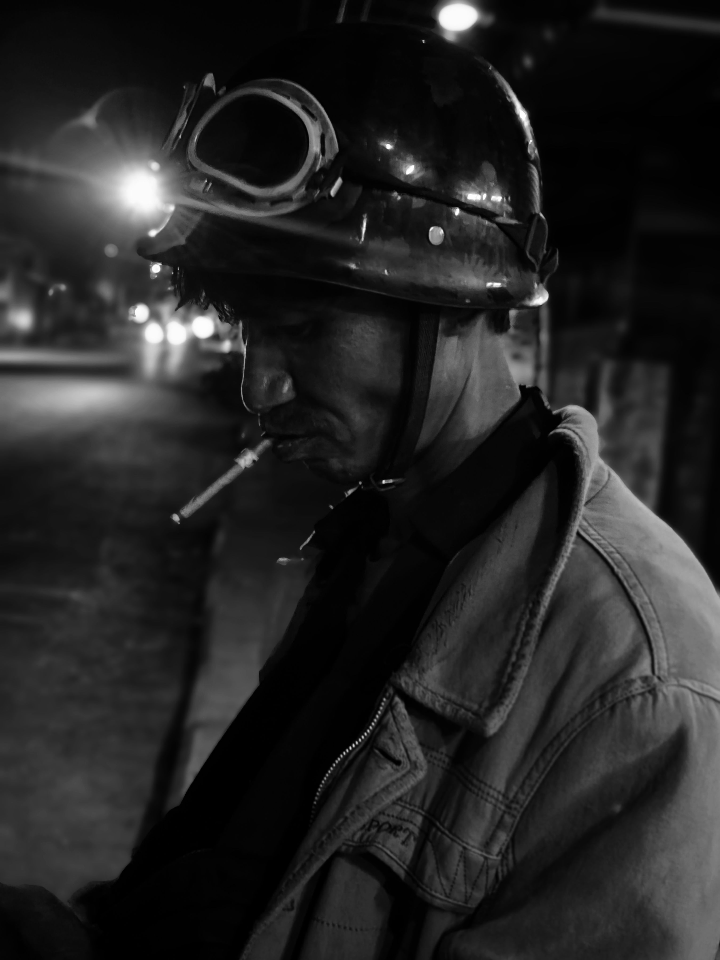 Worker Wearing a Helmet, Smoking a Cigarette at Night · Free Stock Photo