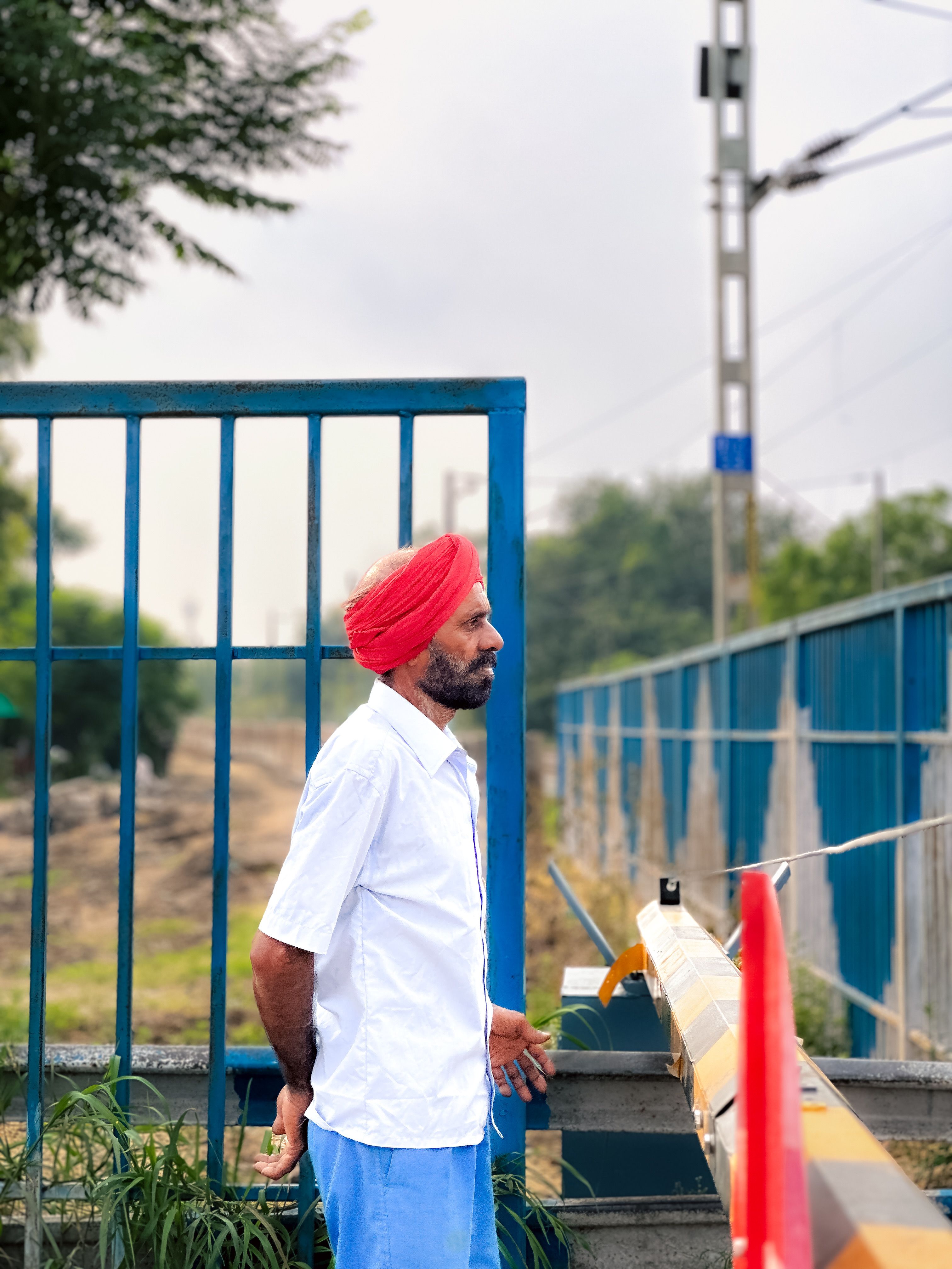 Side View of a Bearded Man Wearing a Turban Standing by the Fence ...