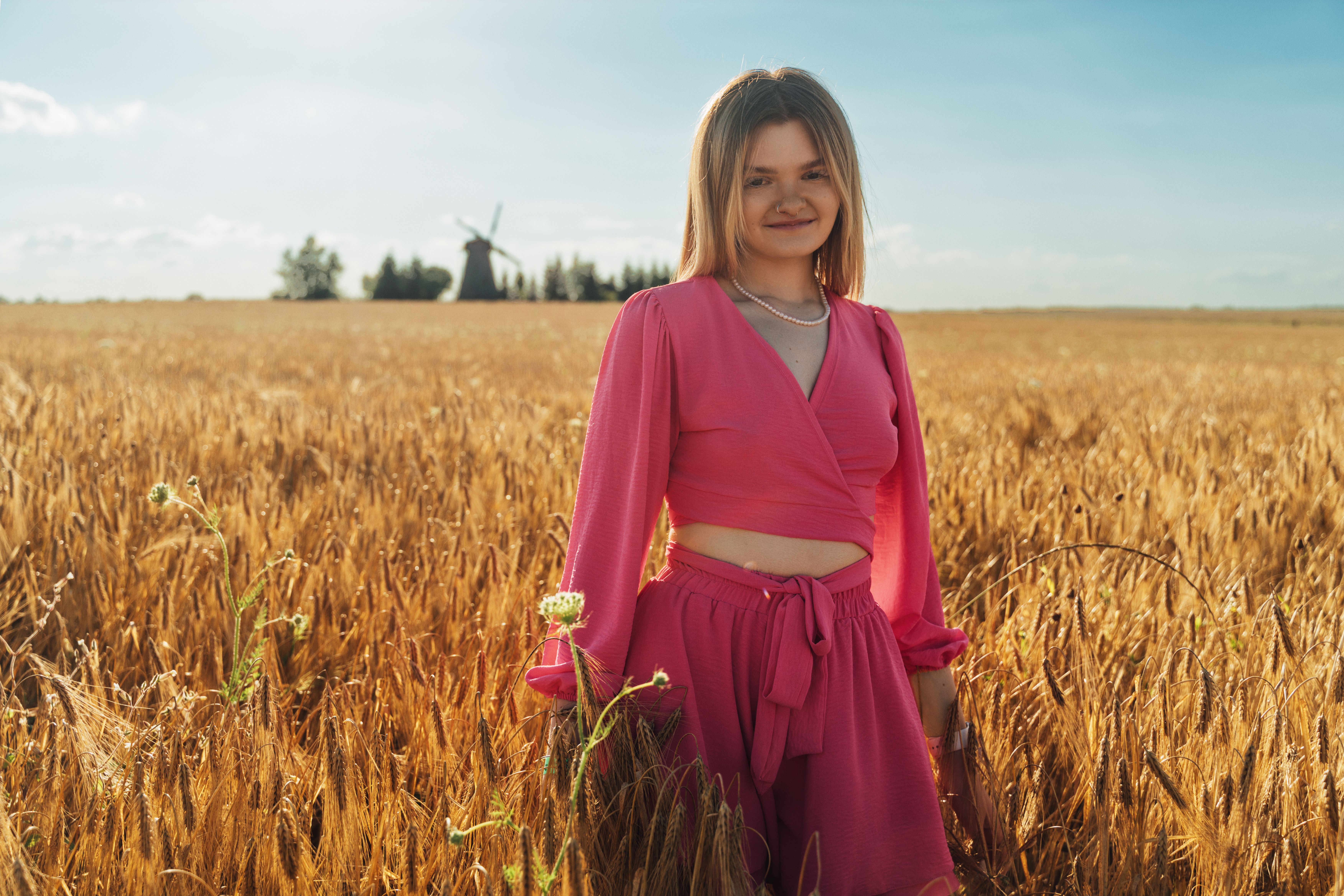 Portrait of a Smiling Teenage Girl Dressed in Pink Standing in a Rye ...