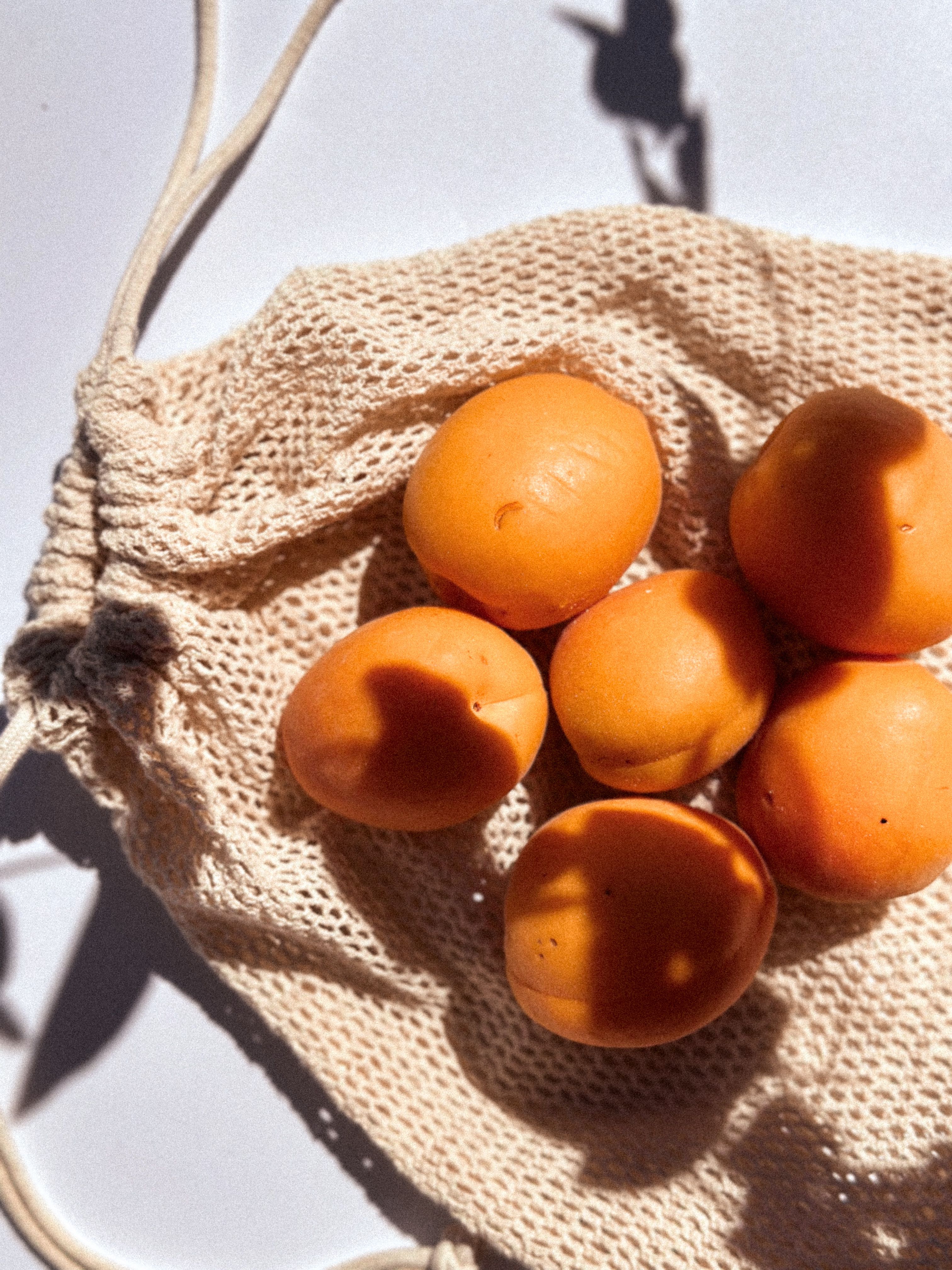 Apricots from String Bag on Ceramic Plate · Free Stock Photo
