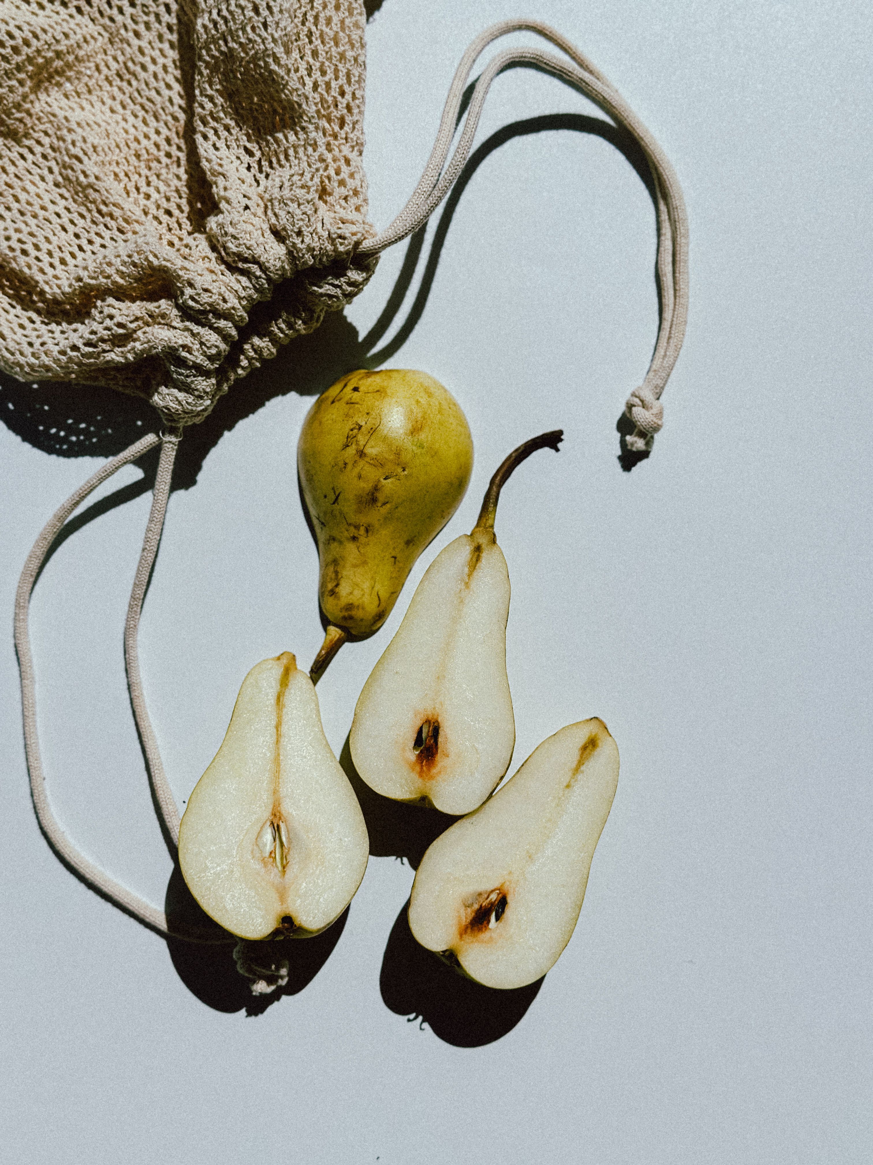 Pears Lying on White Surface next to Bag · Free Stock Photo