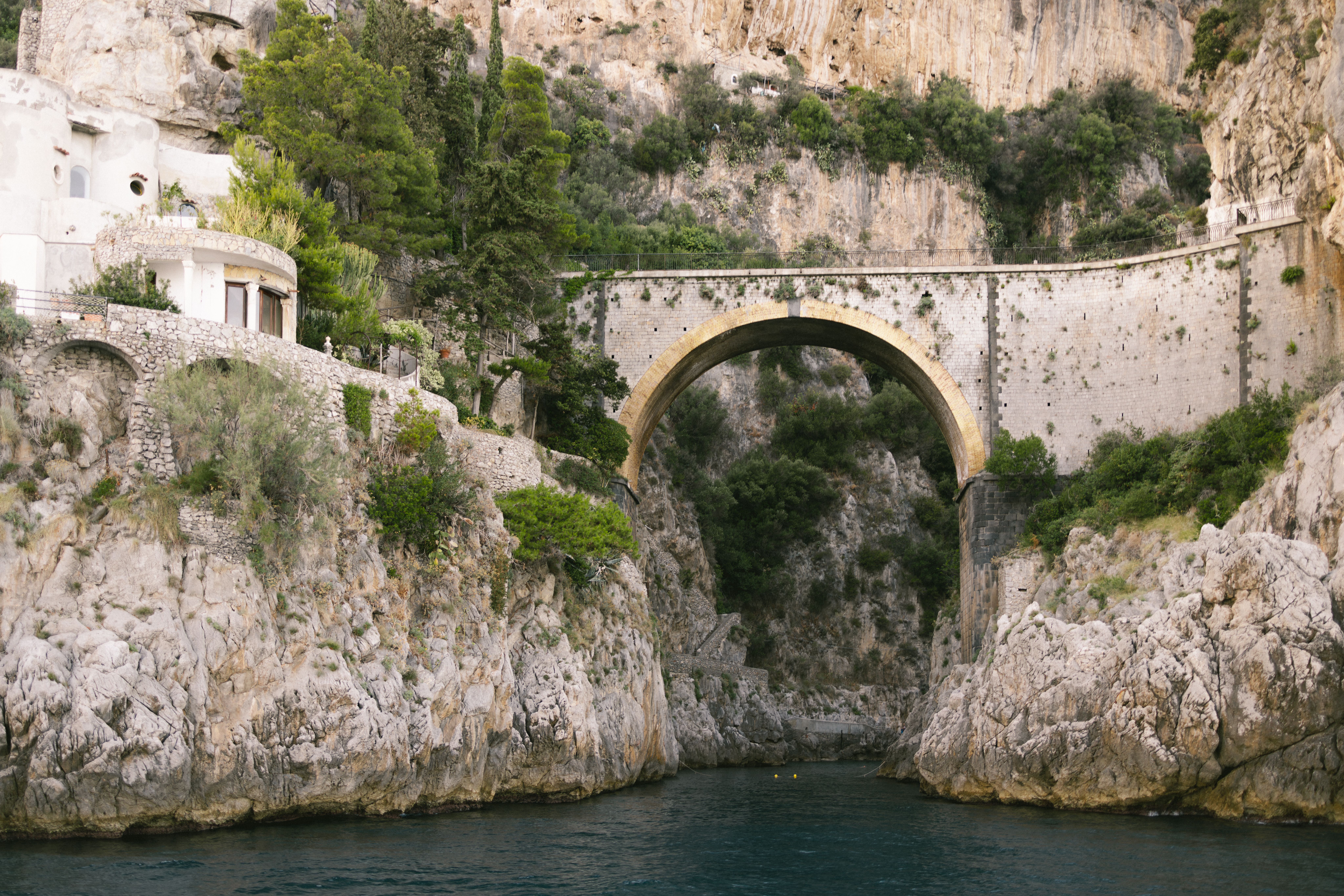 A bridge over the water with a stone arch · Free Stock Photo
