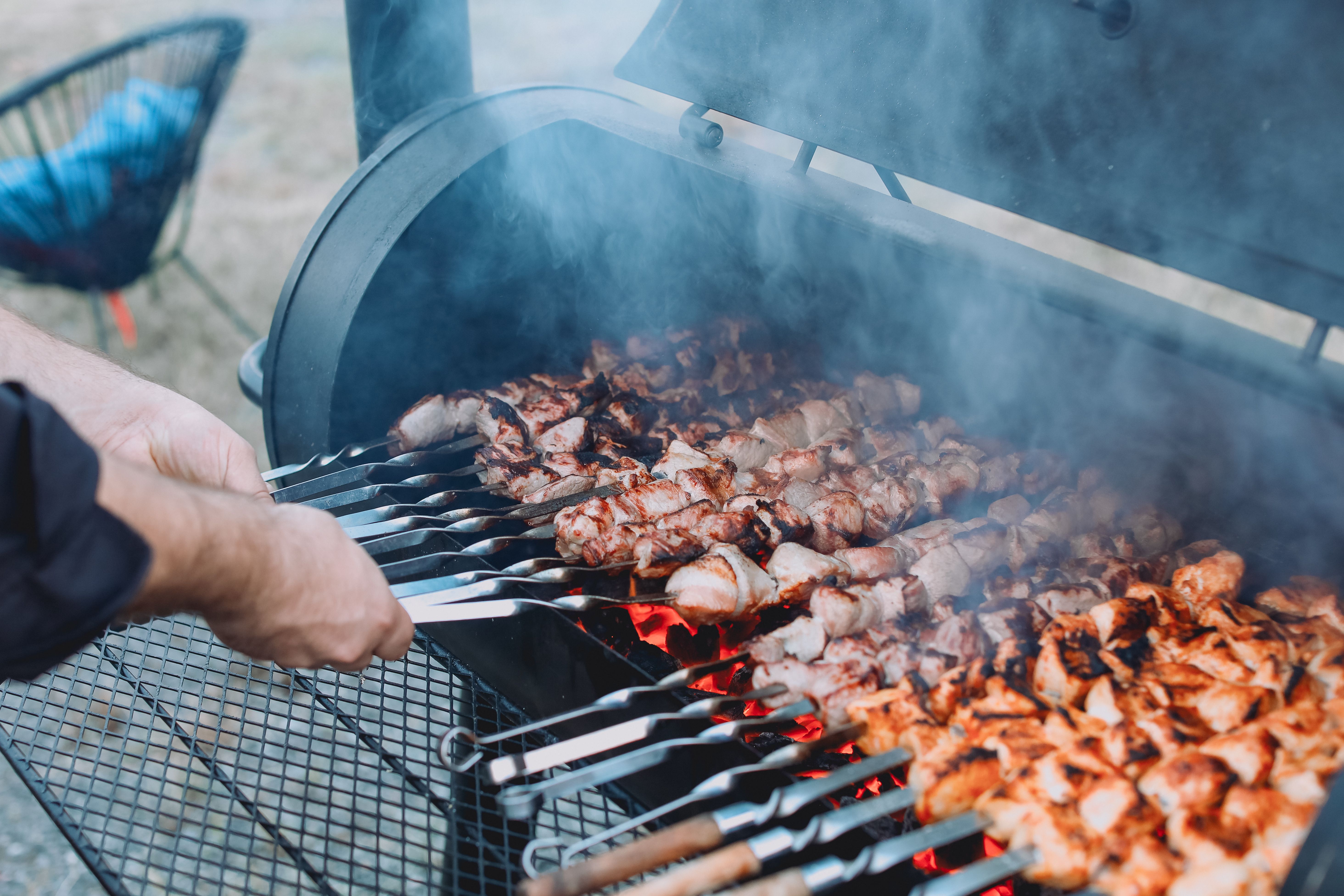 A person is cooking meat on a grill · Free Stock Photo