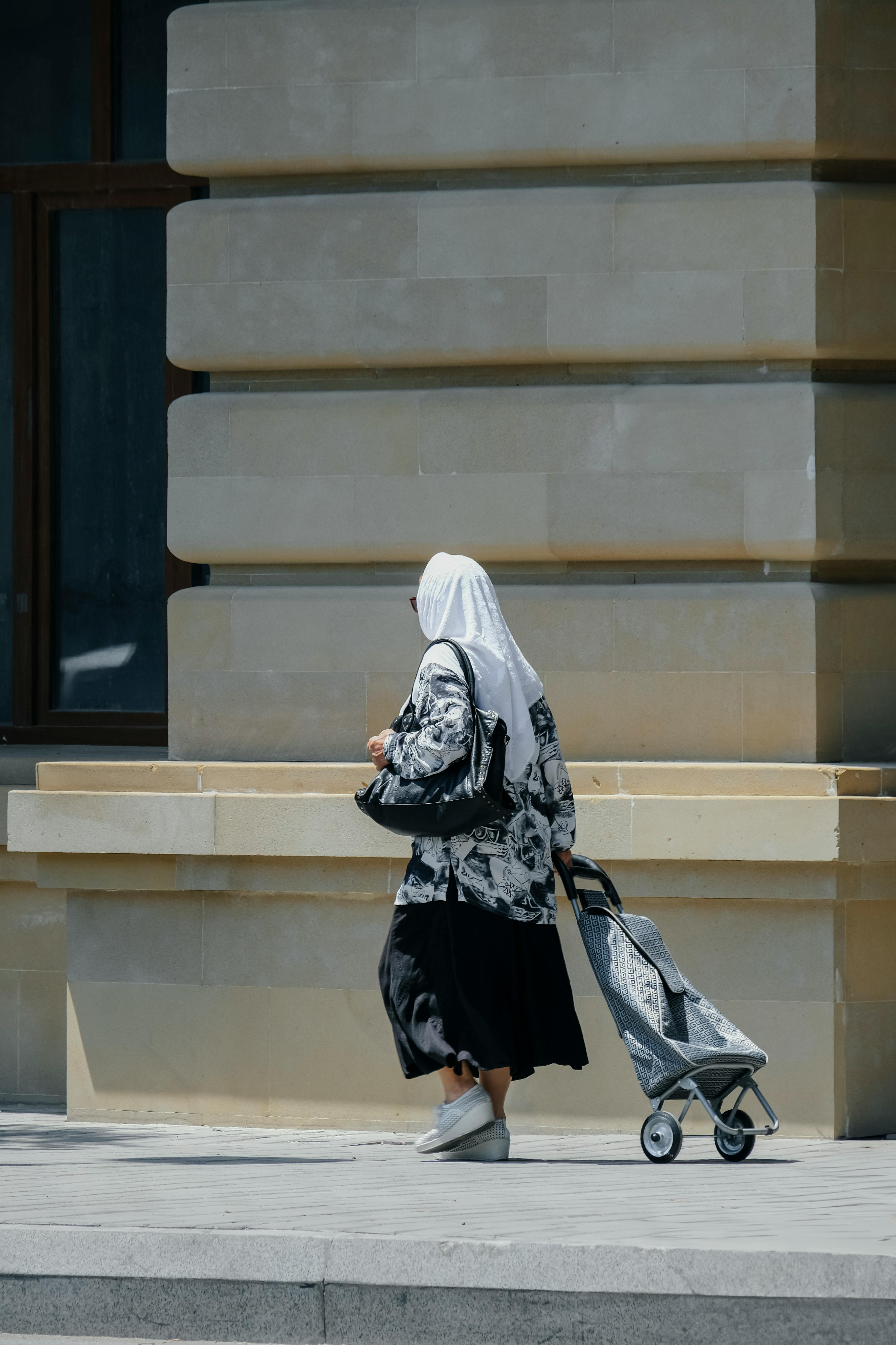 A woman in a hijab walks with a stroller · Free Stock Photo