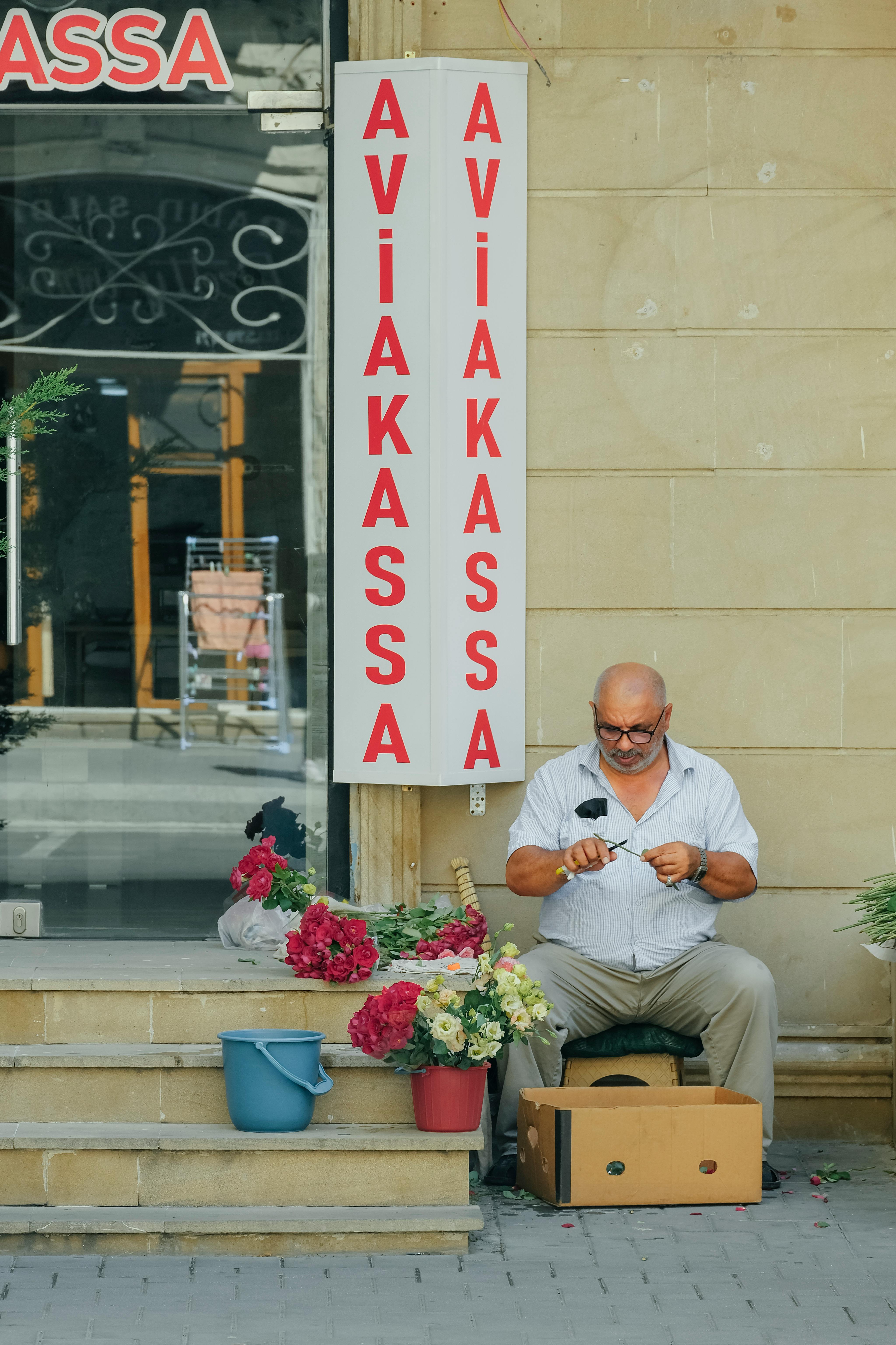 Man Selling Flowers on a Street · Free Stock Photo