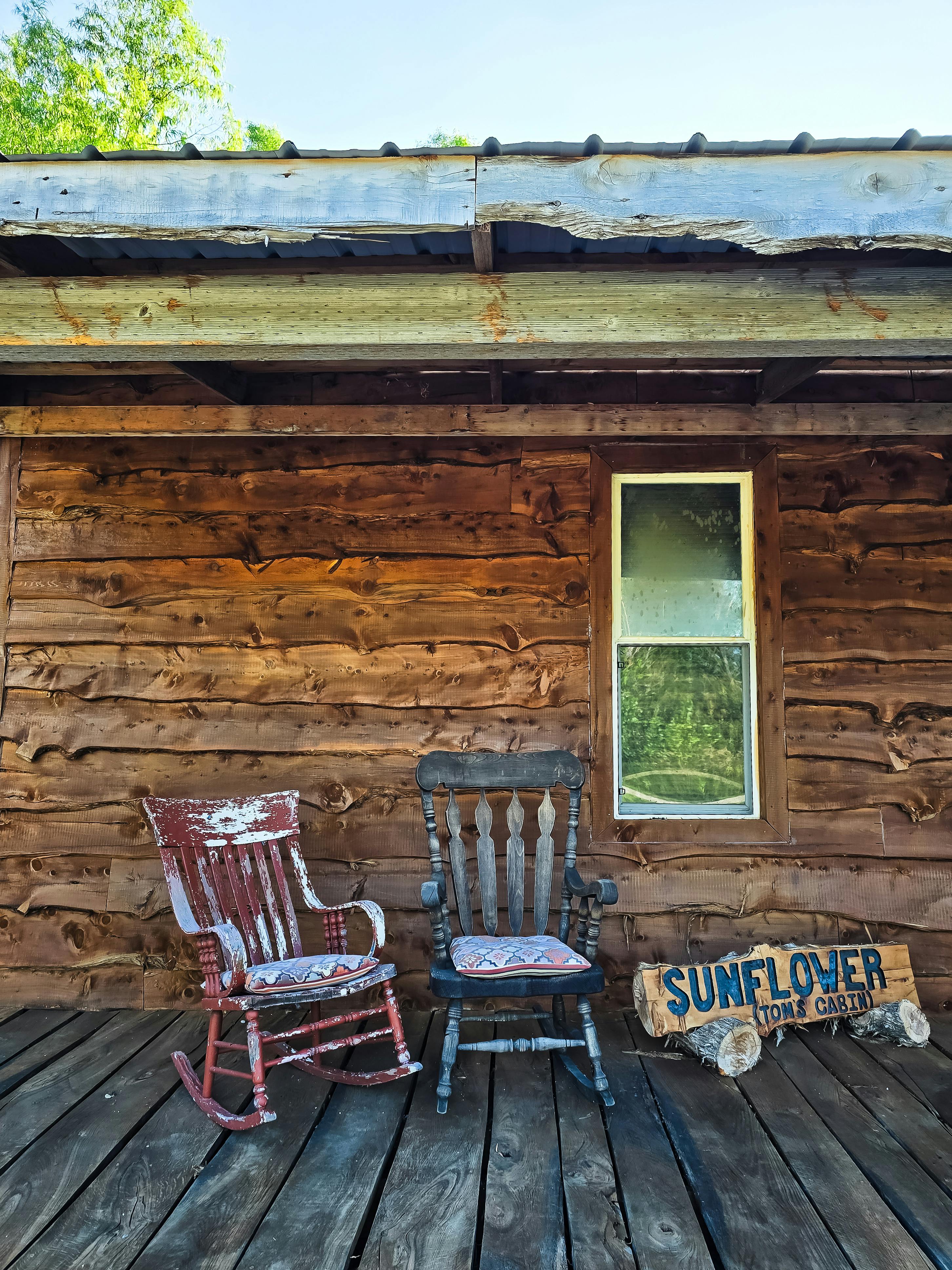 Rocking Chairs Standing on the Porch of a Wooden Cabin · Free Stock Photo