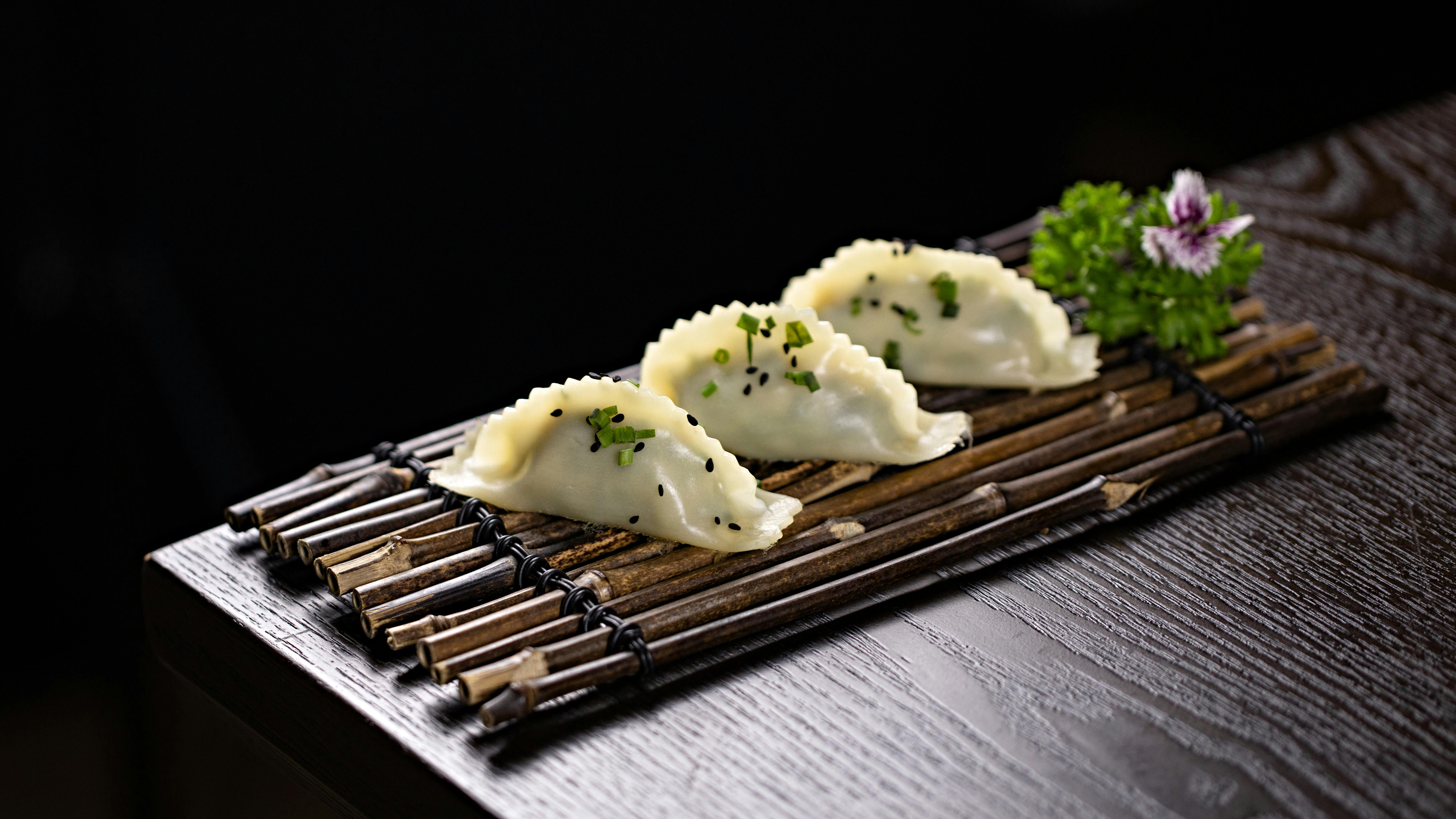 Traditional Asian Dumpling Served on Bamboo Sticks · Free Stock Photo