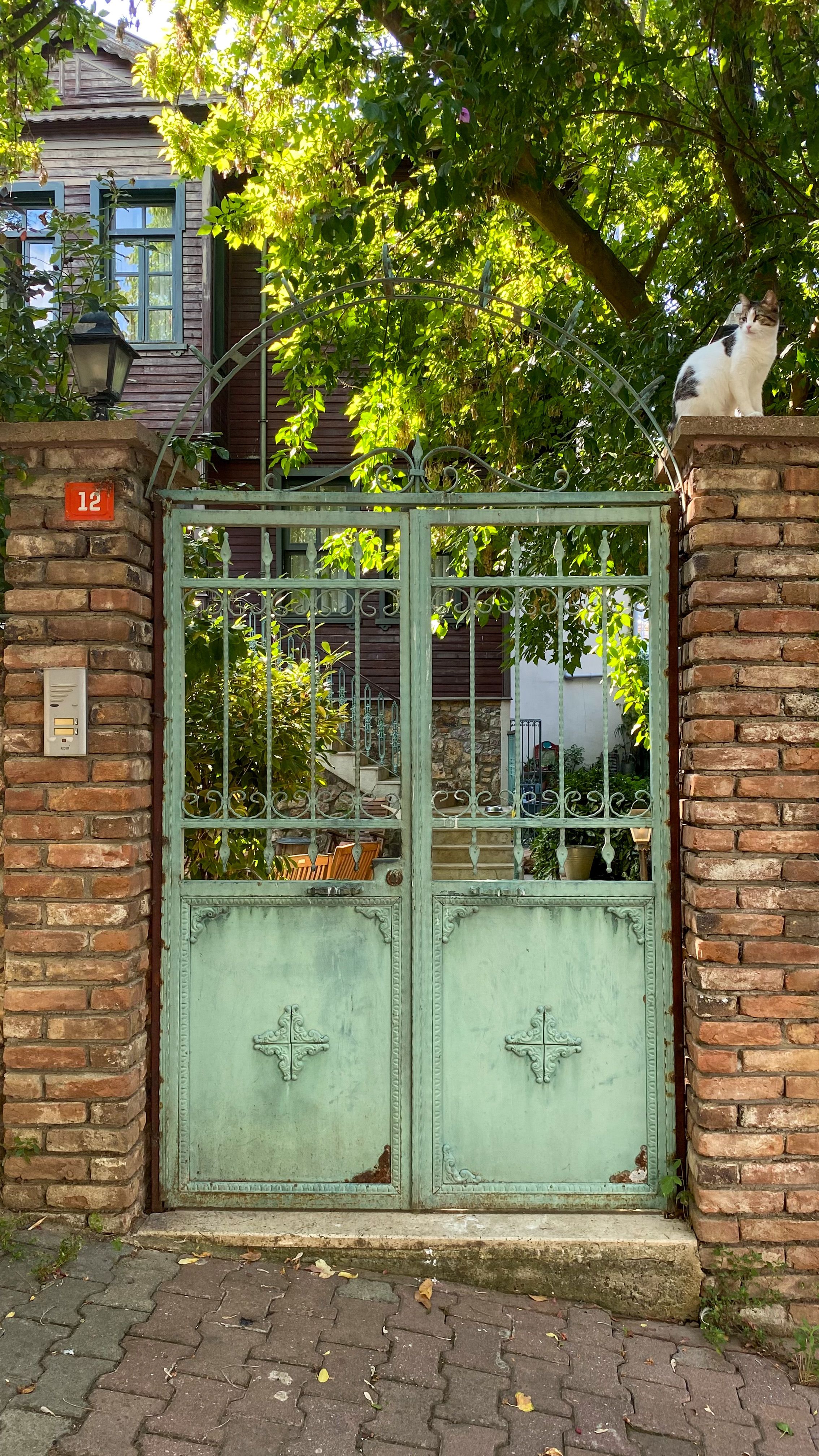 Metal Gate between Brick Poles in Front of a House · Free Stock Photo