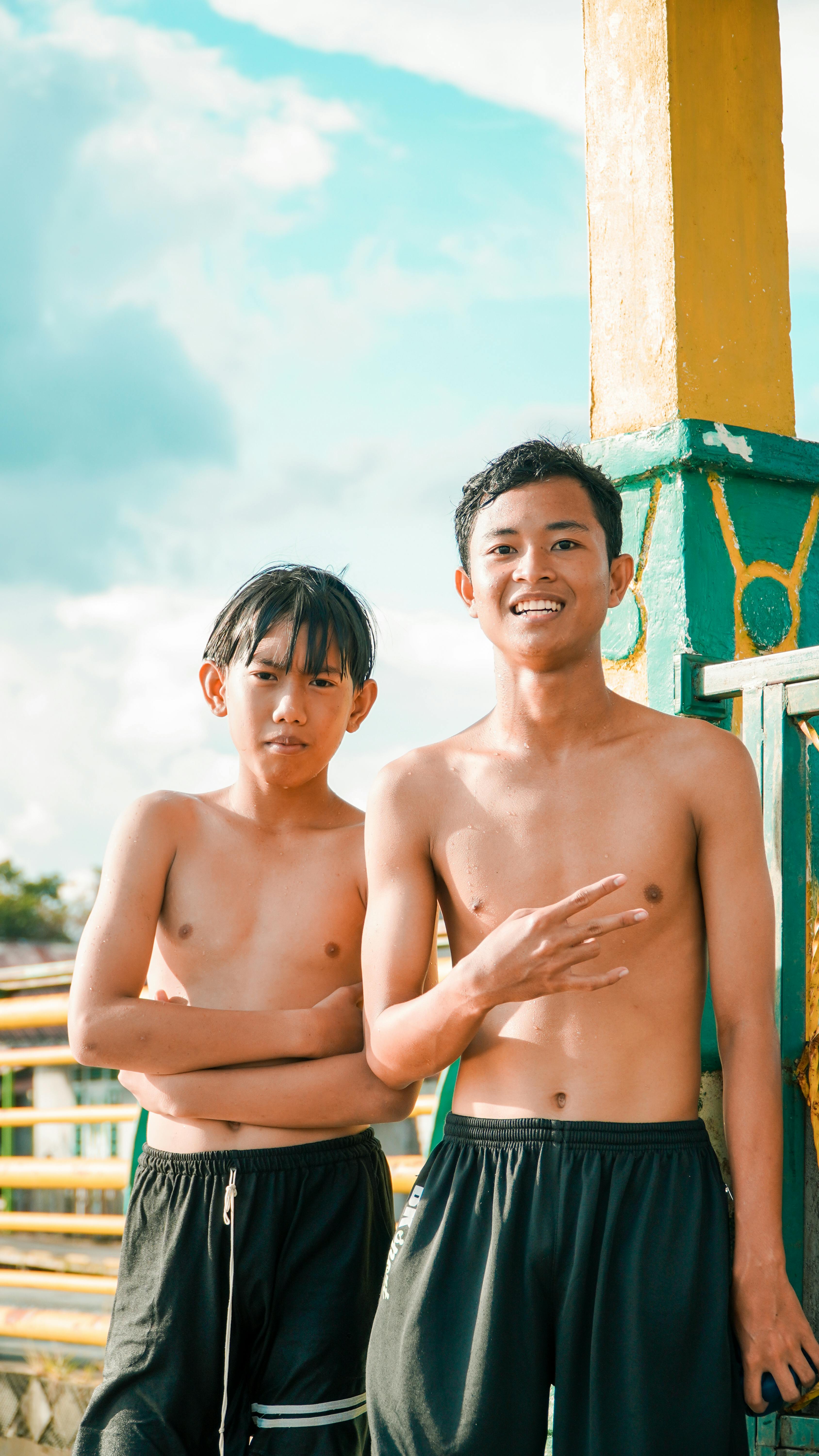 Boys Without Shirts on a Street in Sunlight · Free Stock Photo