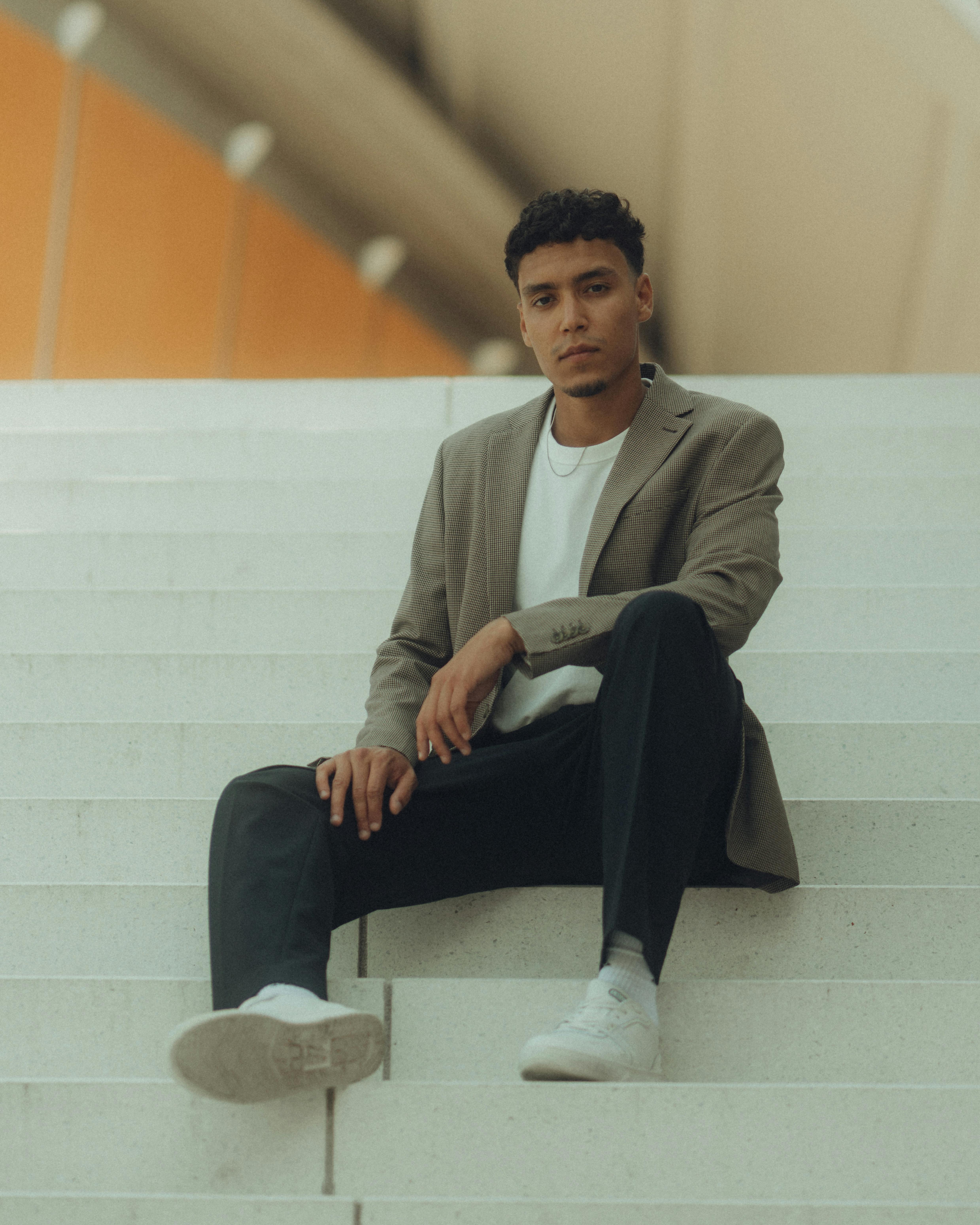 A Fashionable Man Sitting on the Stairs · Free Stock Photo