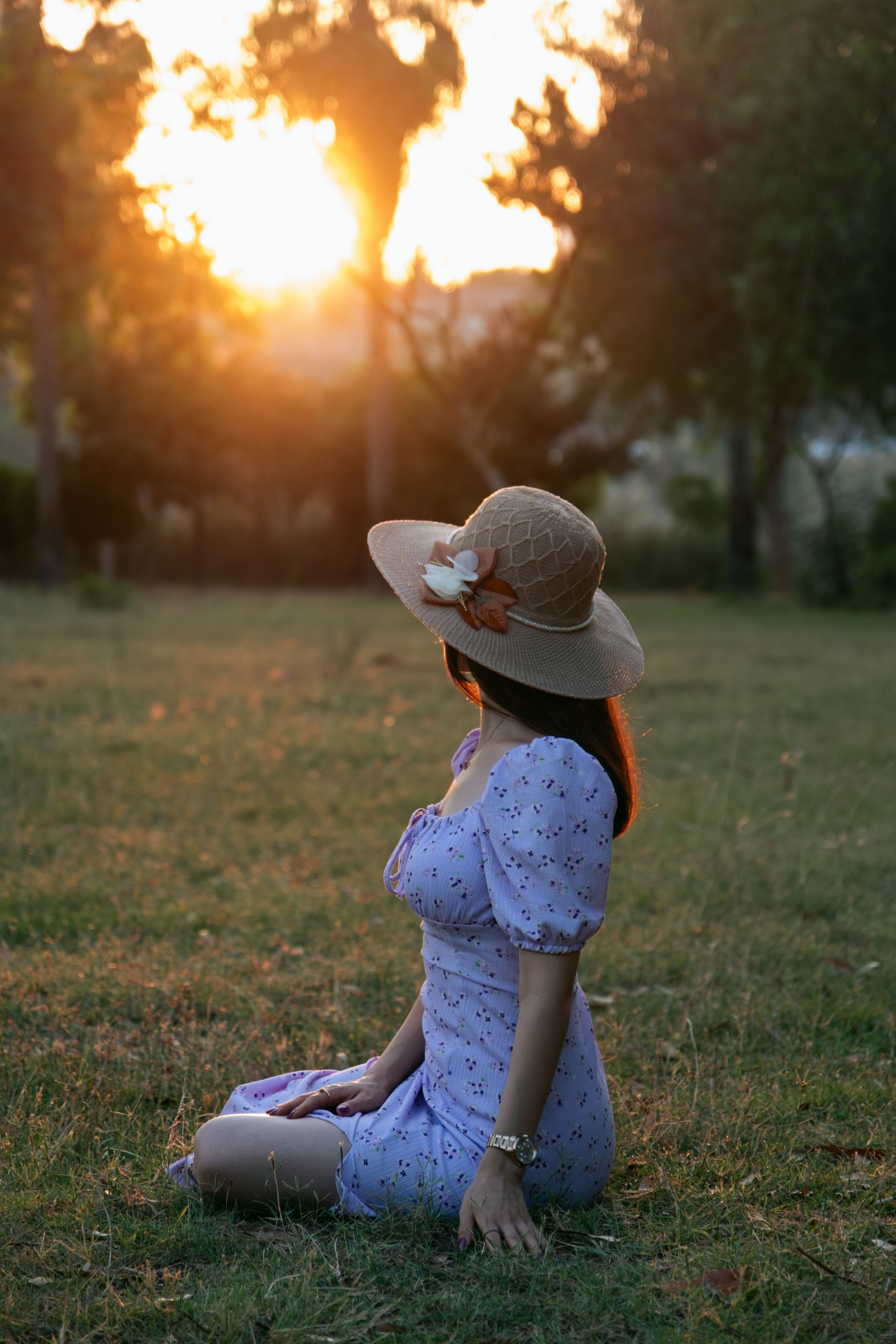 Woman in Purple Summer Dress and Sun Hat Watching Sunset While Sitting ...