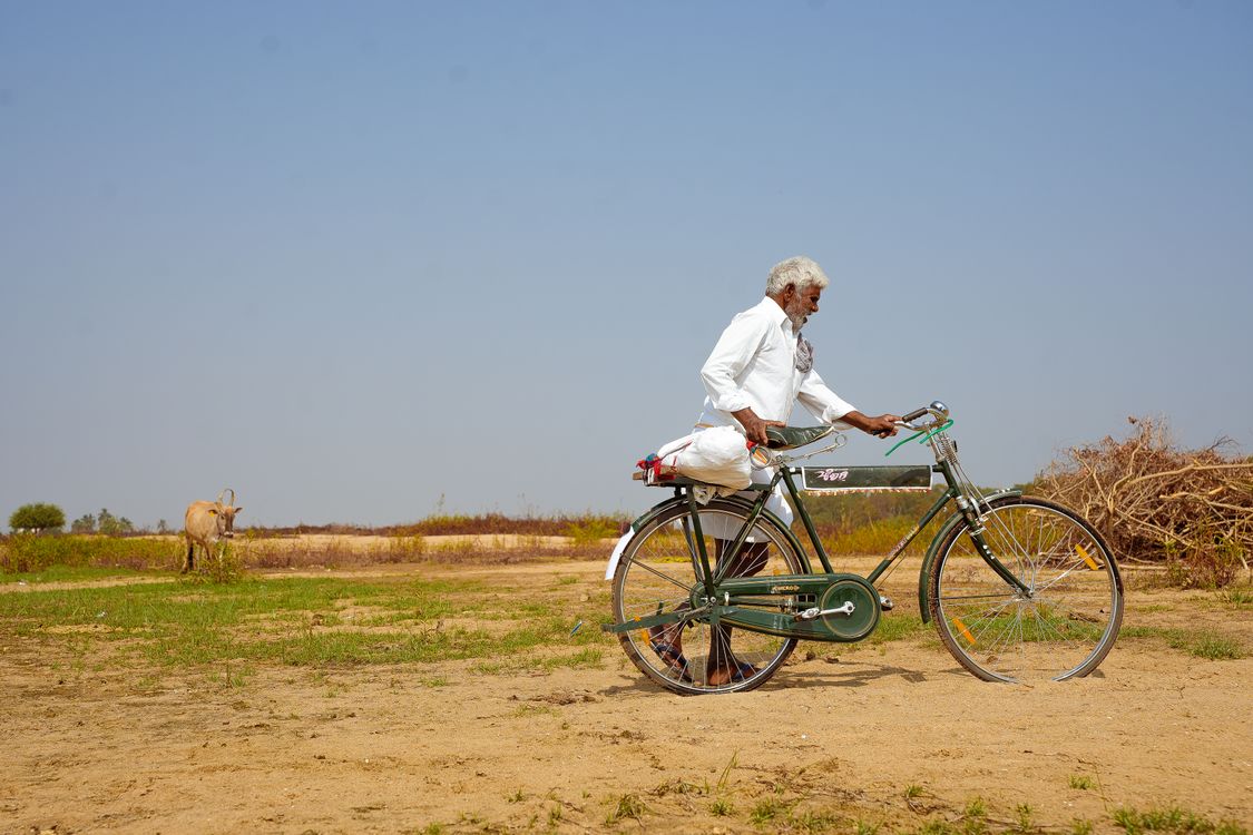 Elderly Man Walking with Bike in Countryside · Free Stock Photo