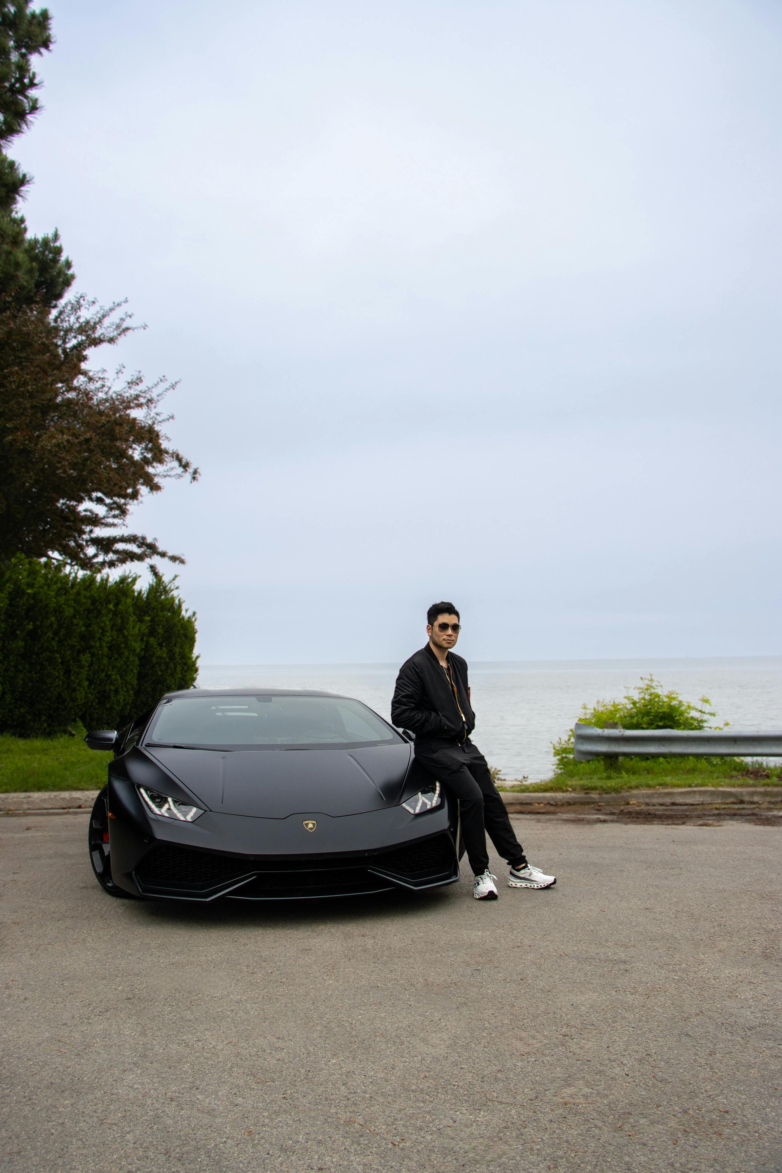 Man in Jacket Standing with Lamborghini Huracan · Free Stock Photo