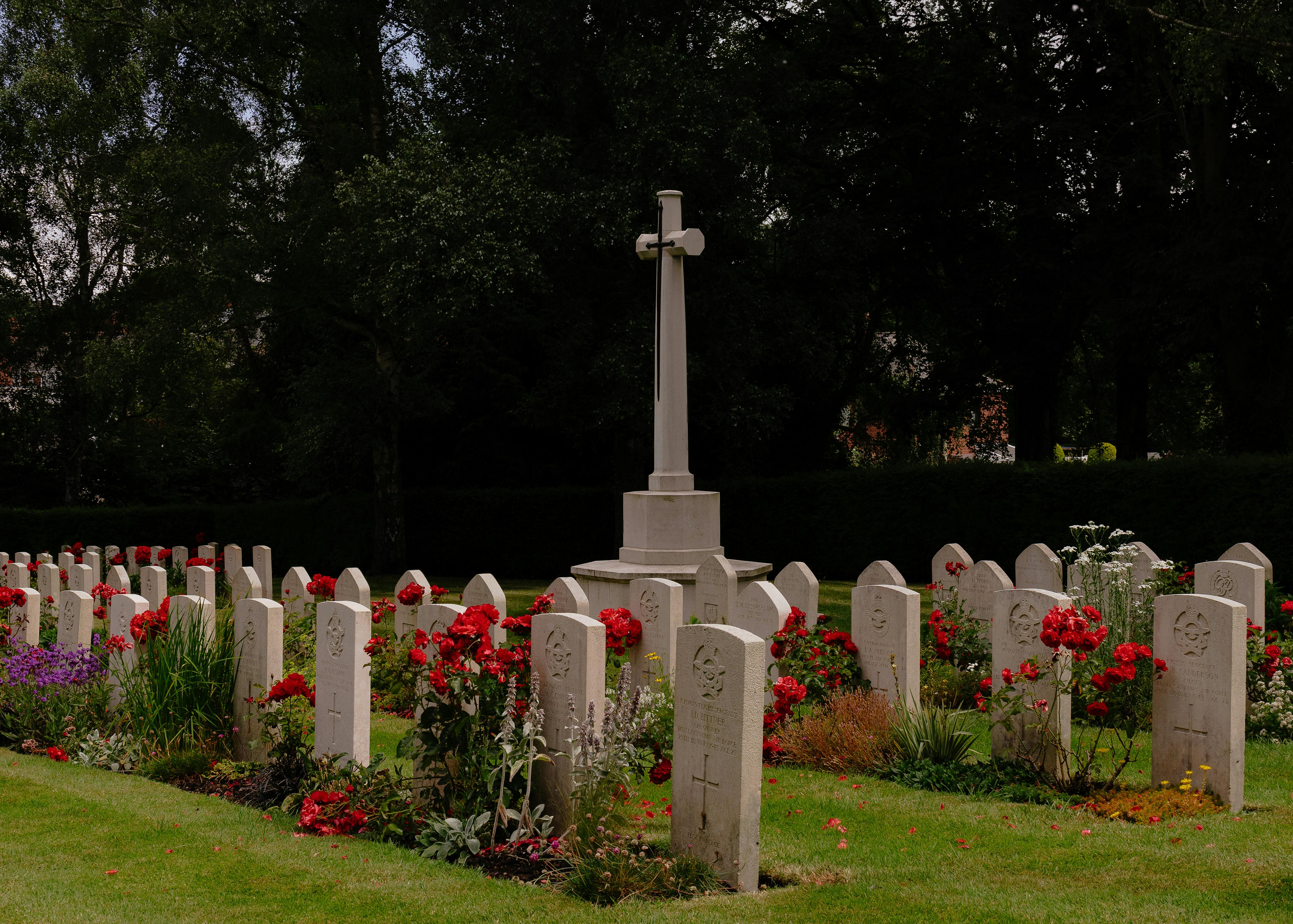 Flowers around Gravestones at Cemetery · Free Stock Photo
