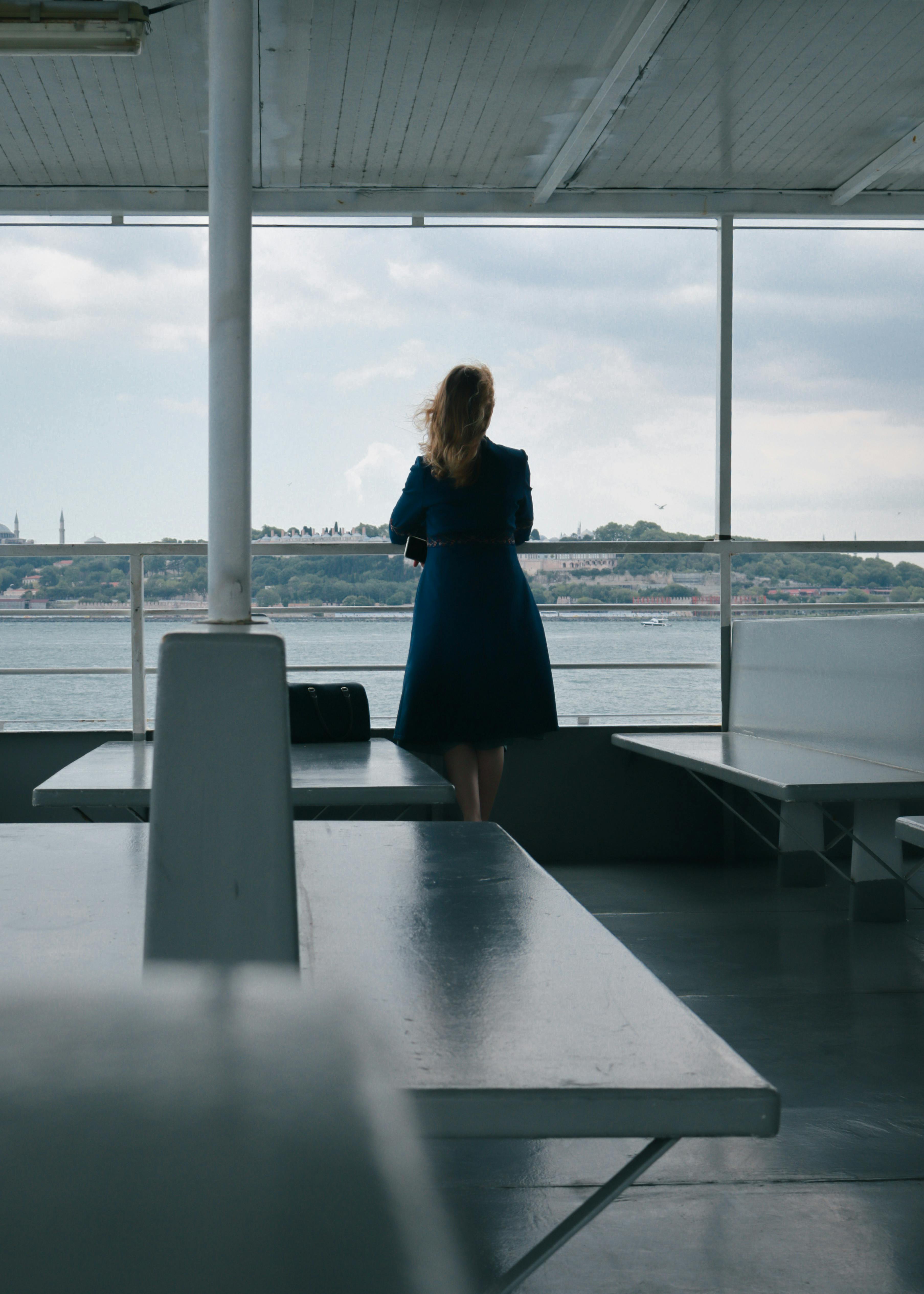 Back View of a Woman Standing on a Ferry and Looking the Sea · Free ...