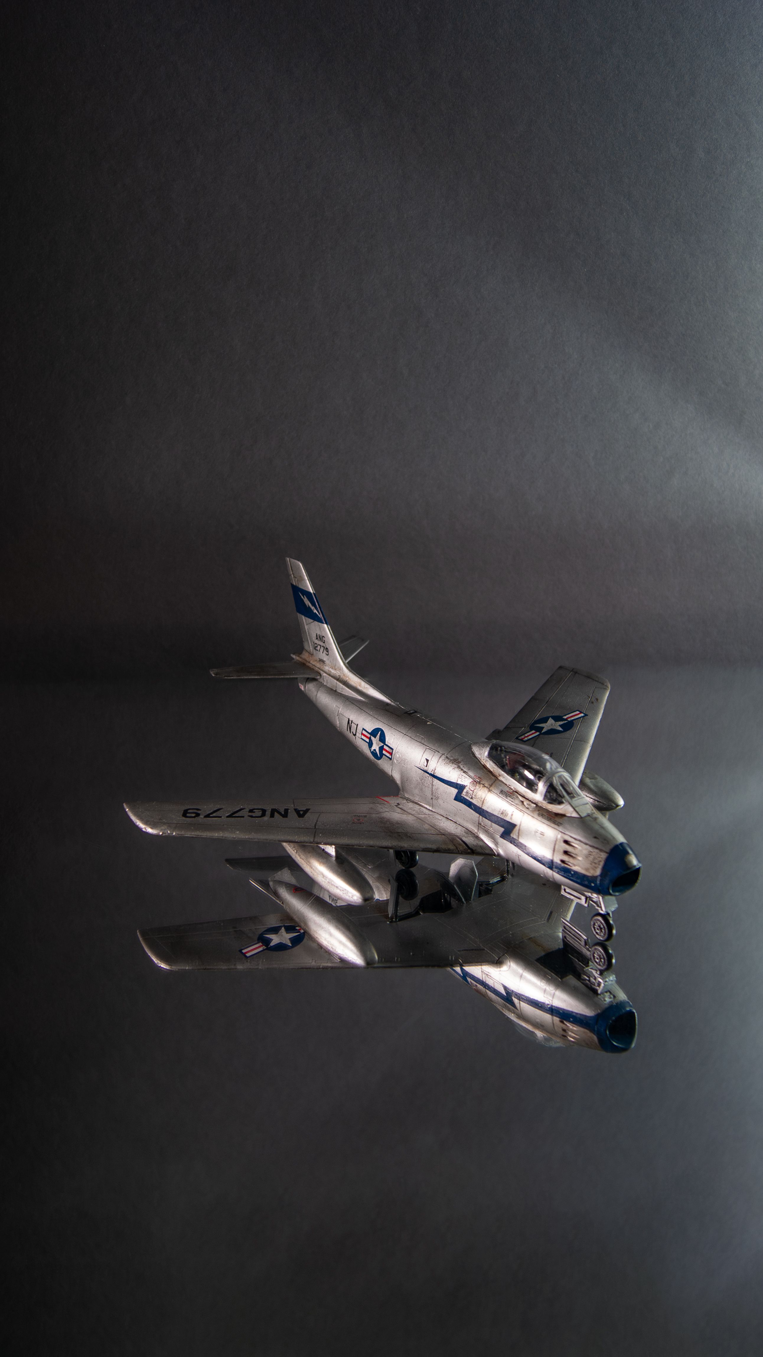 Miniature of the F-86 Sabre Fighter Jet on Mirror · Free Stock Photo