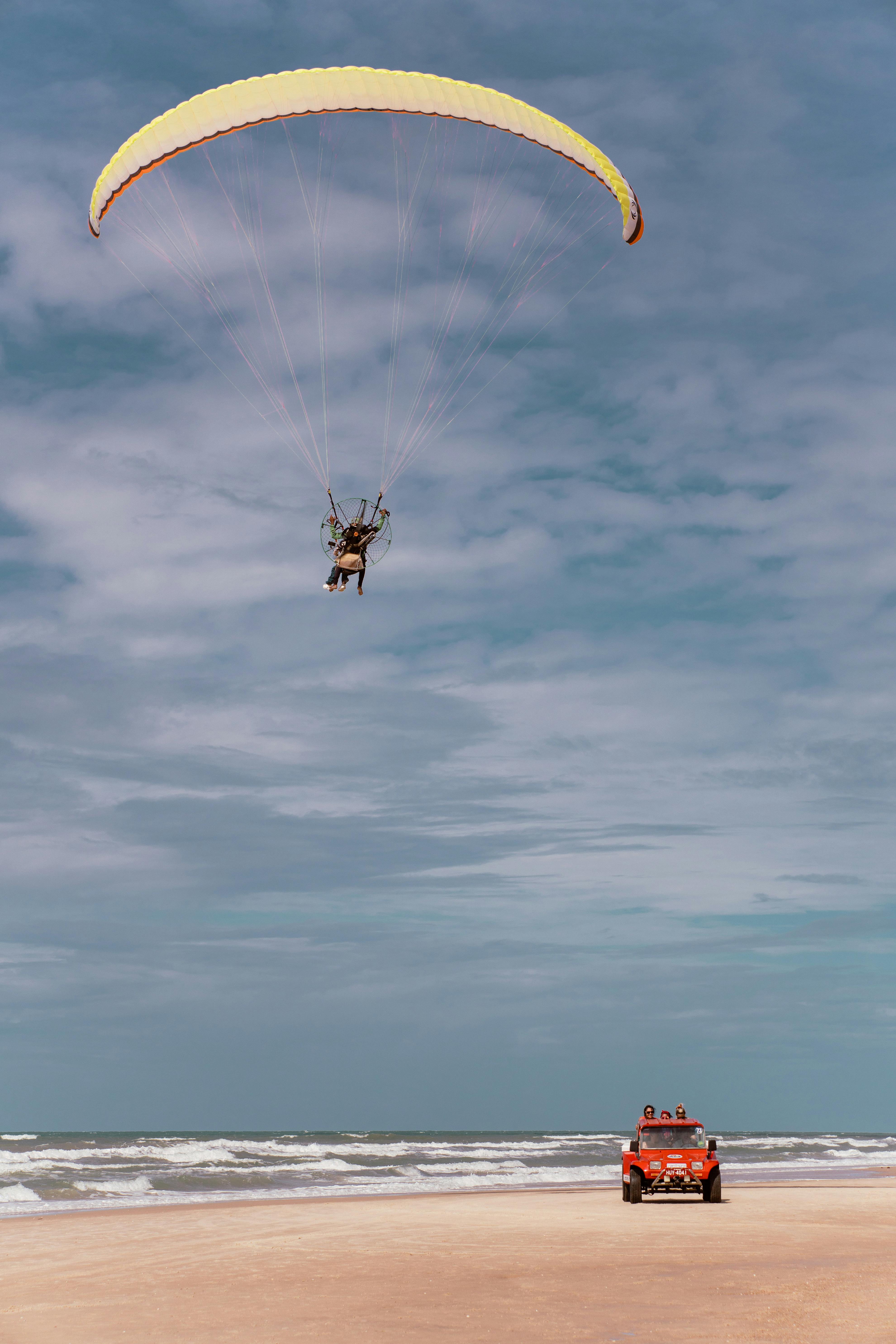 Man Parachuting by the Beach · Free Stock Photo