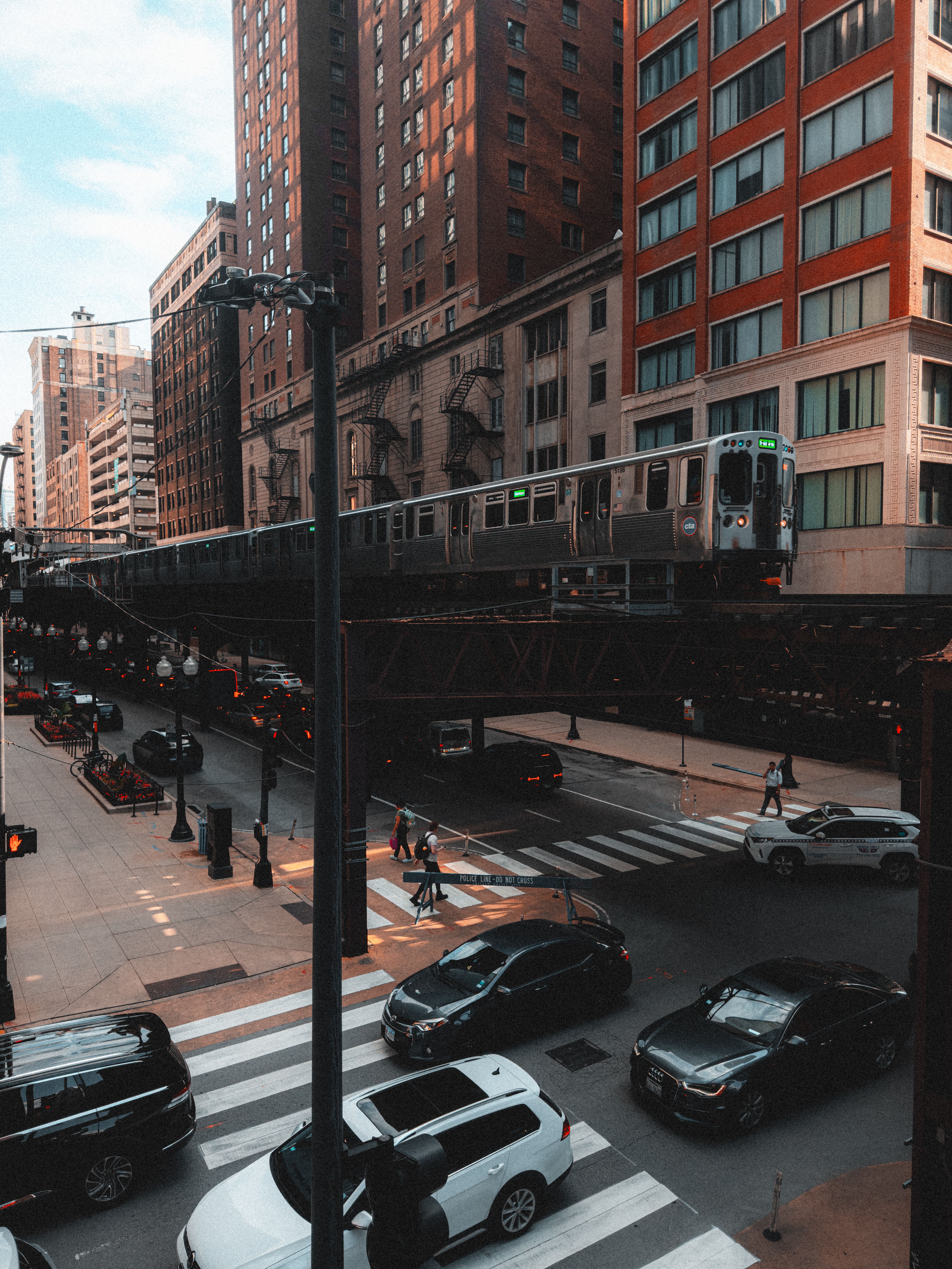 Contemporary city street with high rise buildings and elevated railway ...