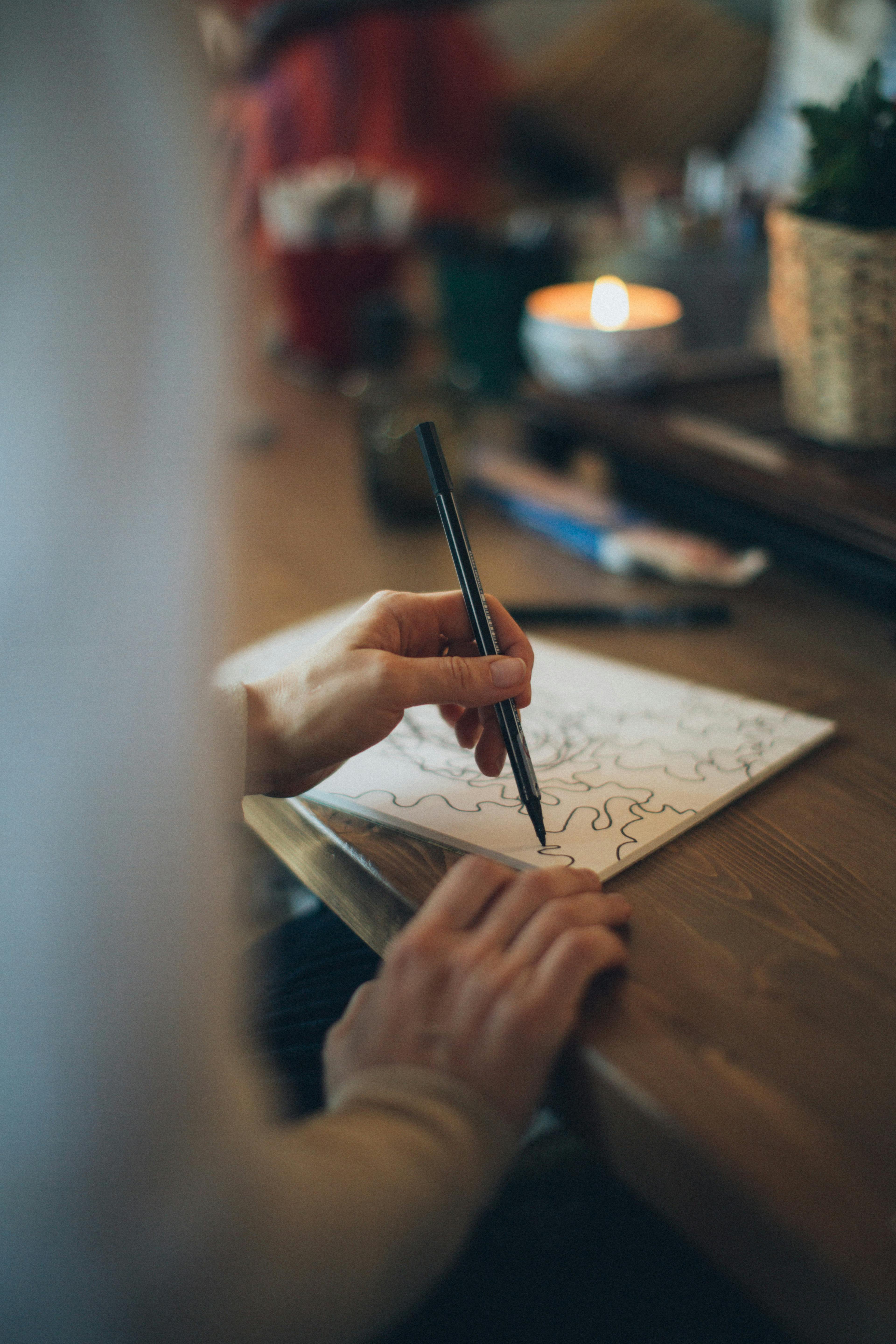 Man Writing on Paper · Free Stock Photo