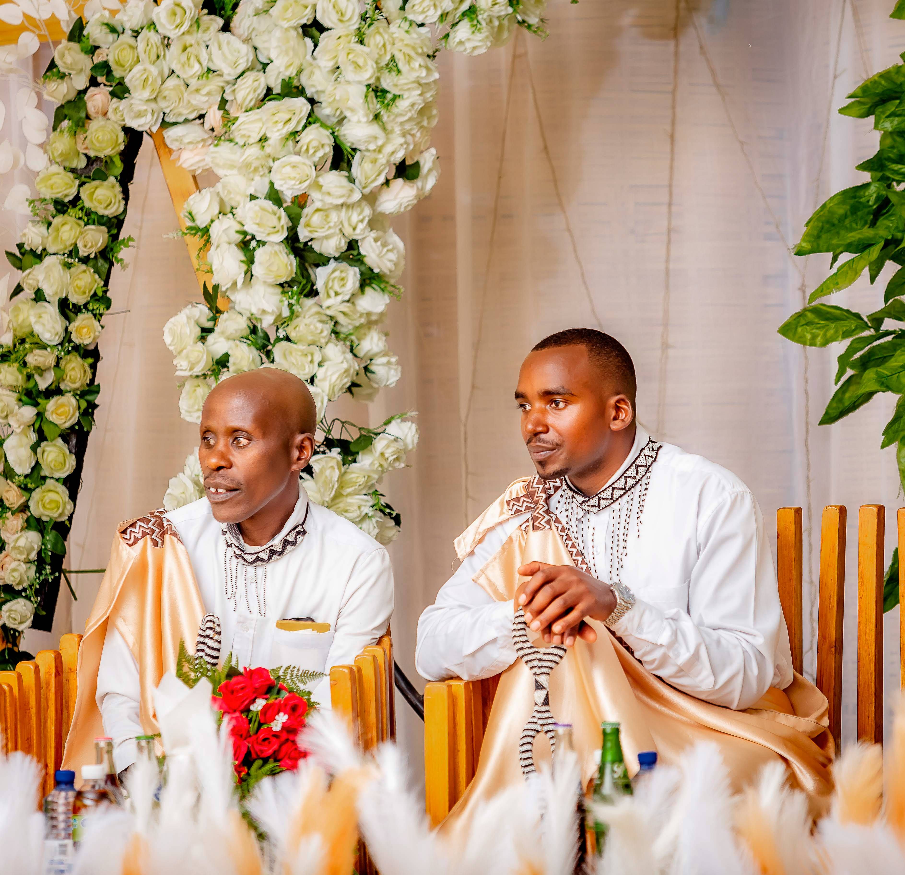 Two men in traditional attire sit at a wedding · Free Stock Photo