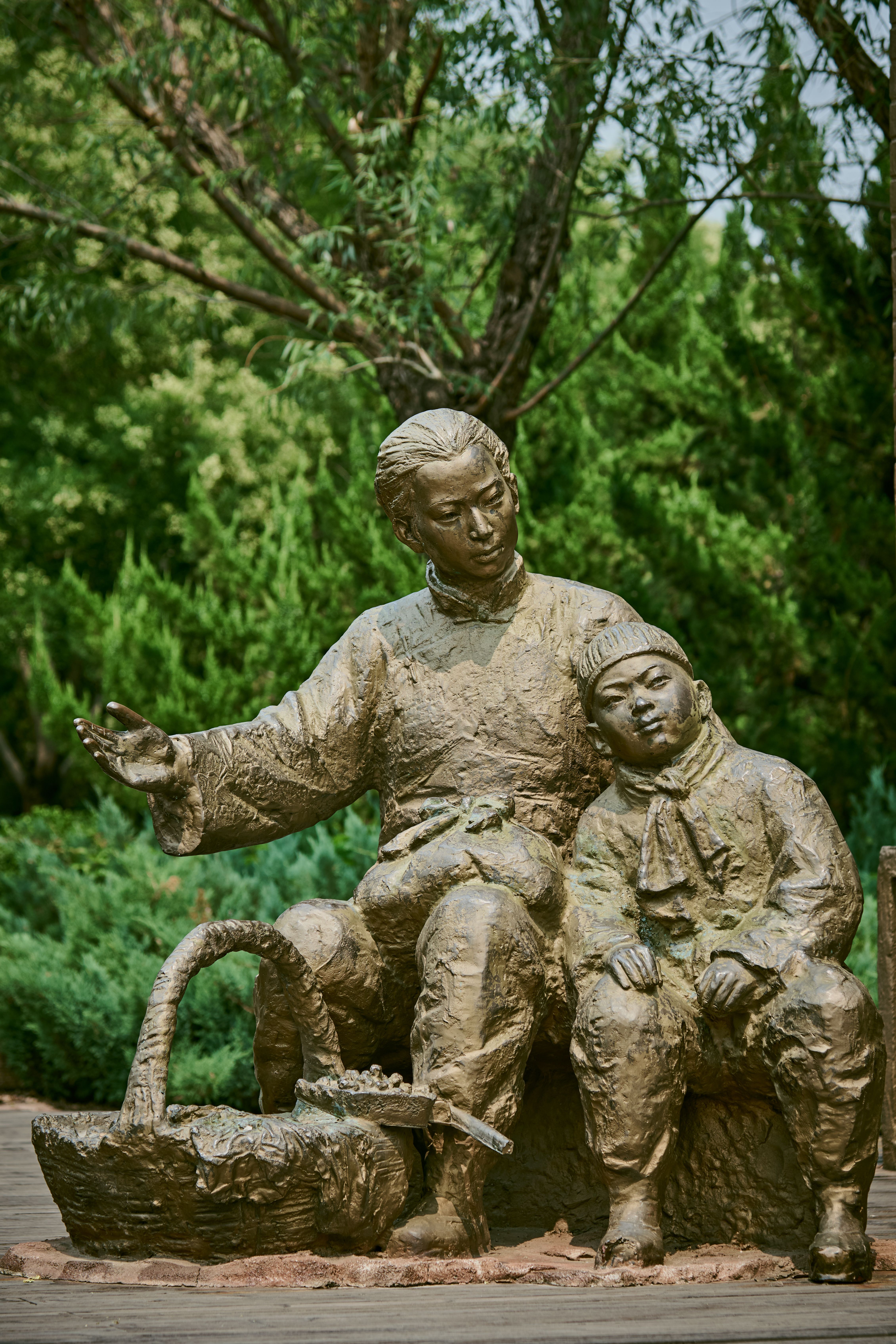 An Asian Statue of a Man And Boy · Free Stock Photo