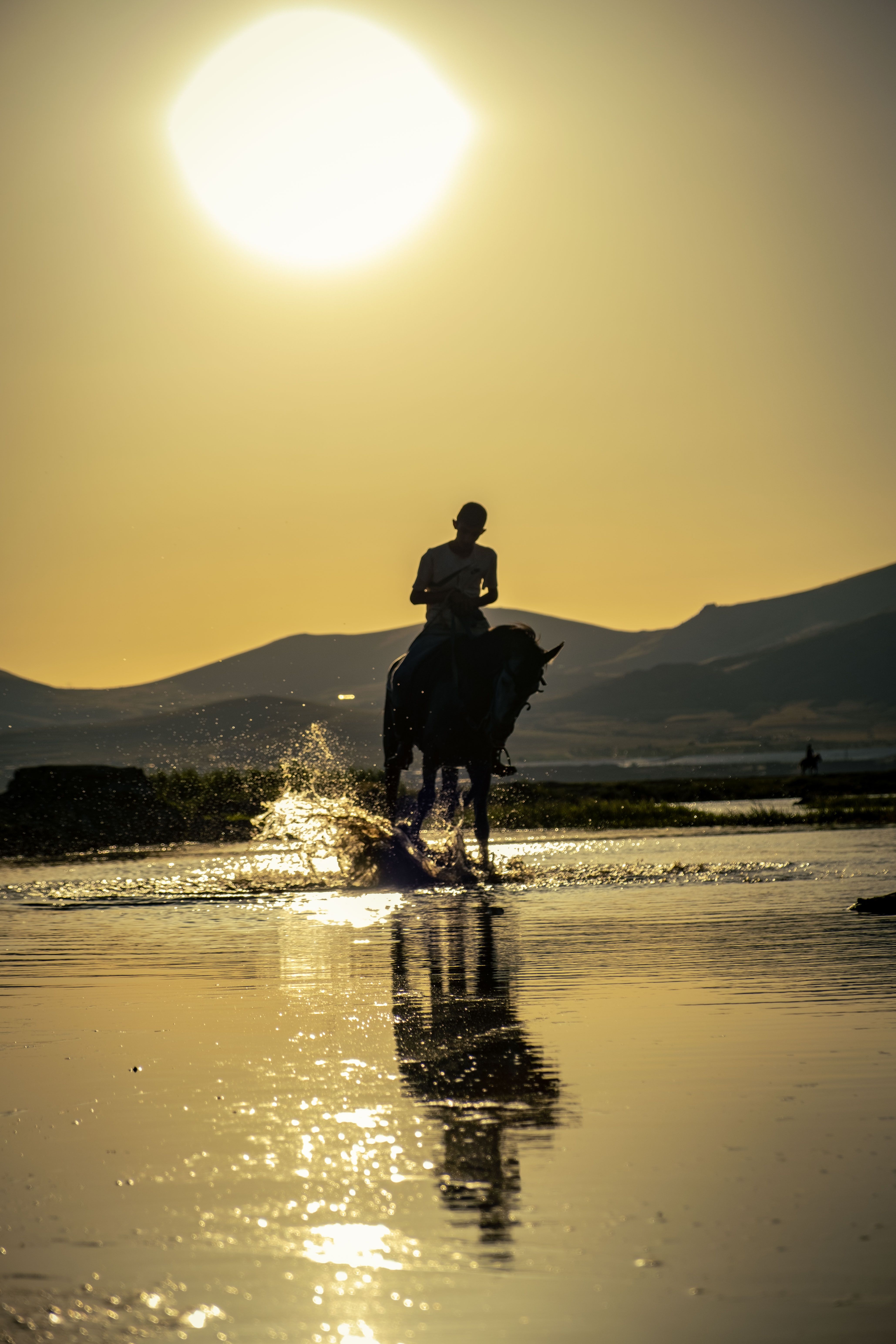 Sun Rising over a Teenage Boy Riding a Horse on a Lakeshore · Free ...