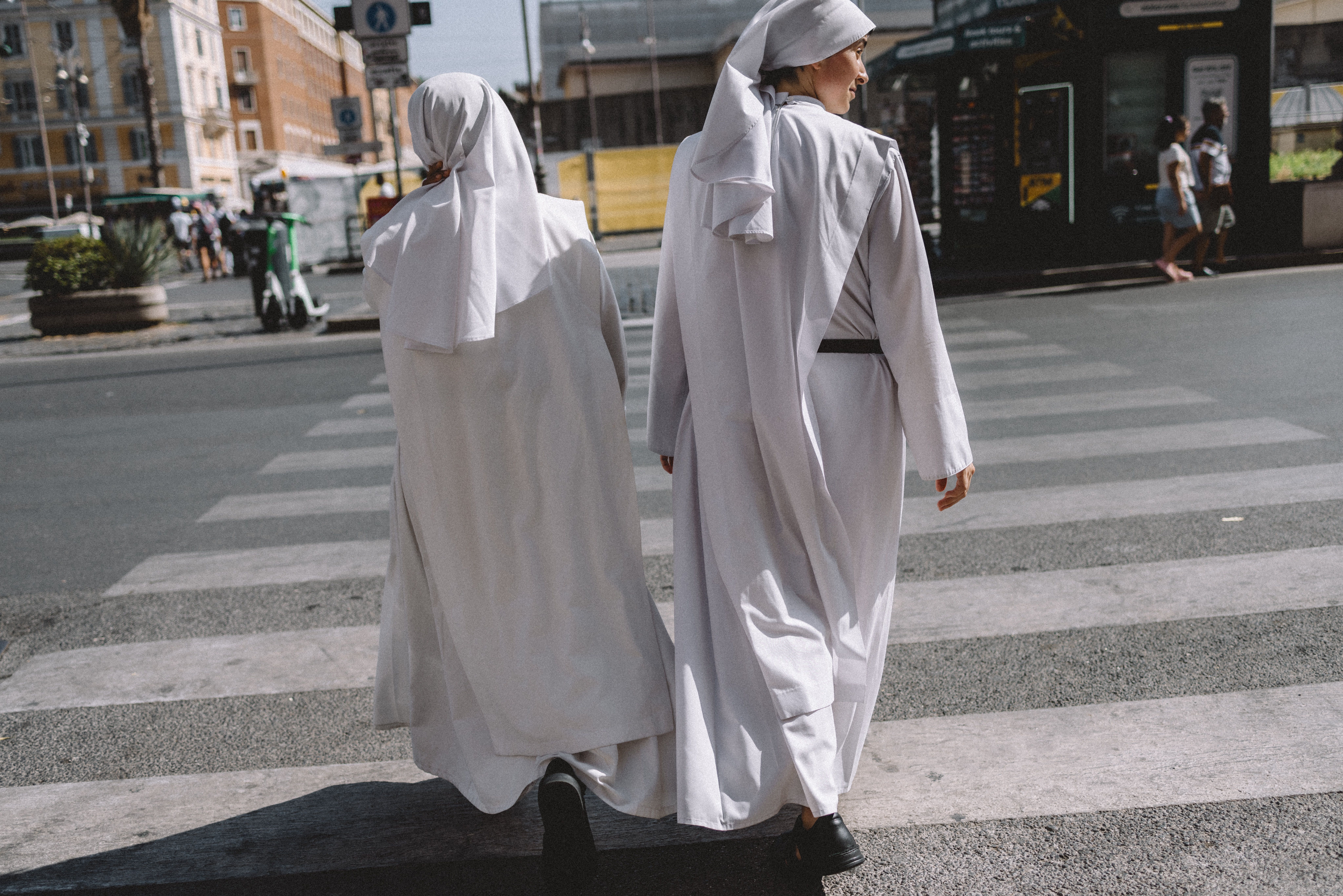 Back View of Two Nuns Walking on a Crosswalk · Free Stock Photo