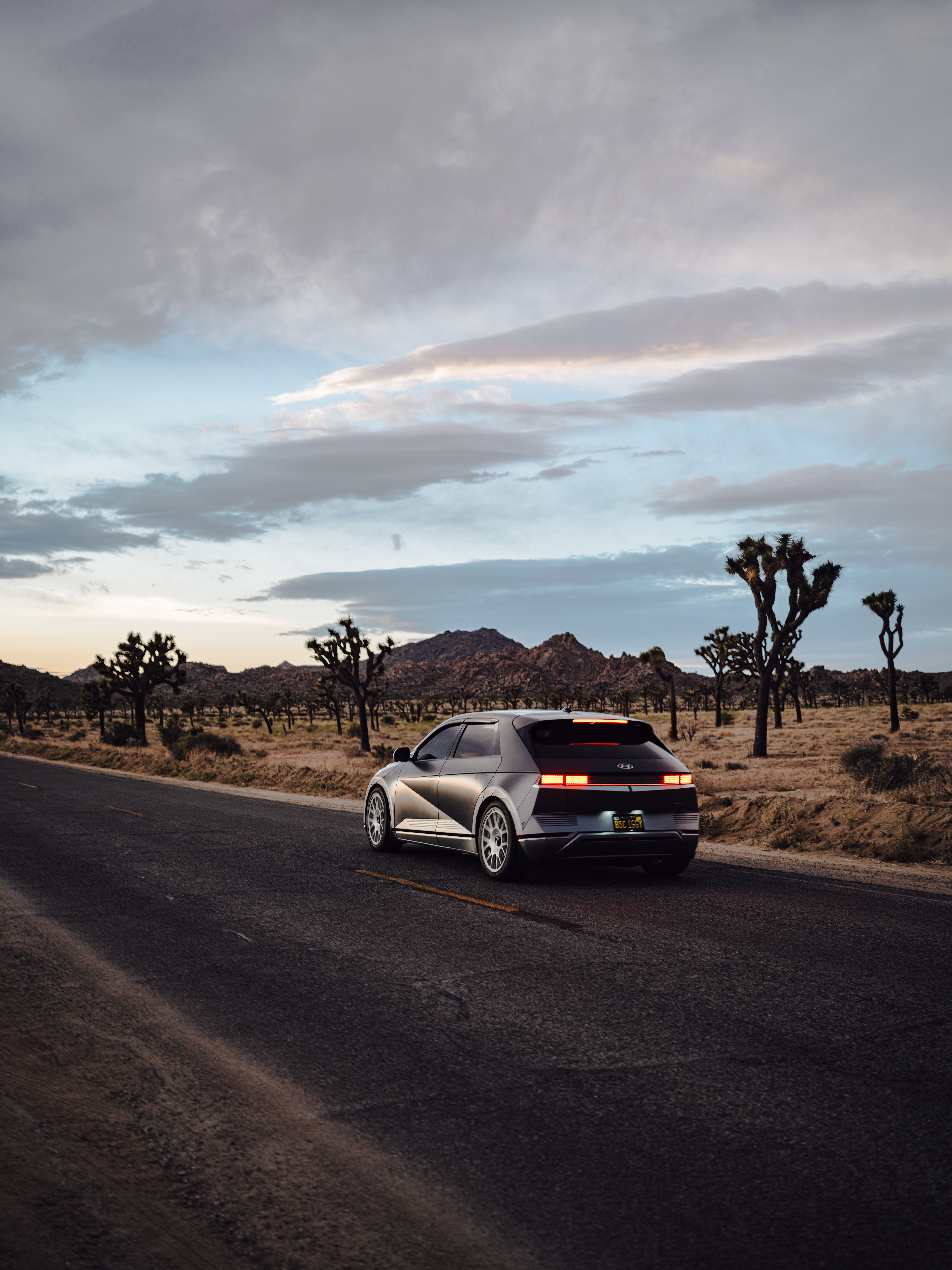 The new toyota prius is driving down a desert road · Free Stock Photo