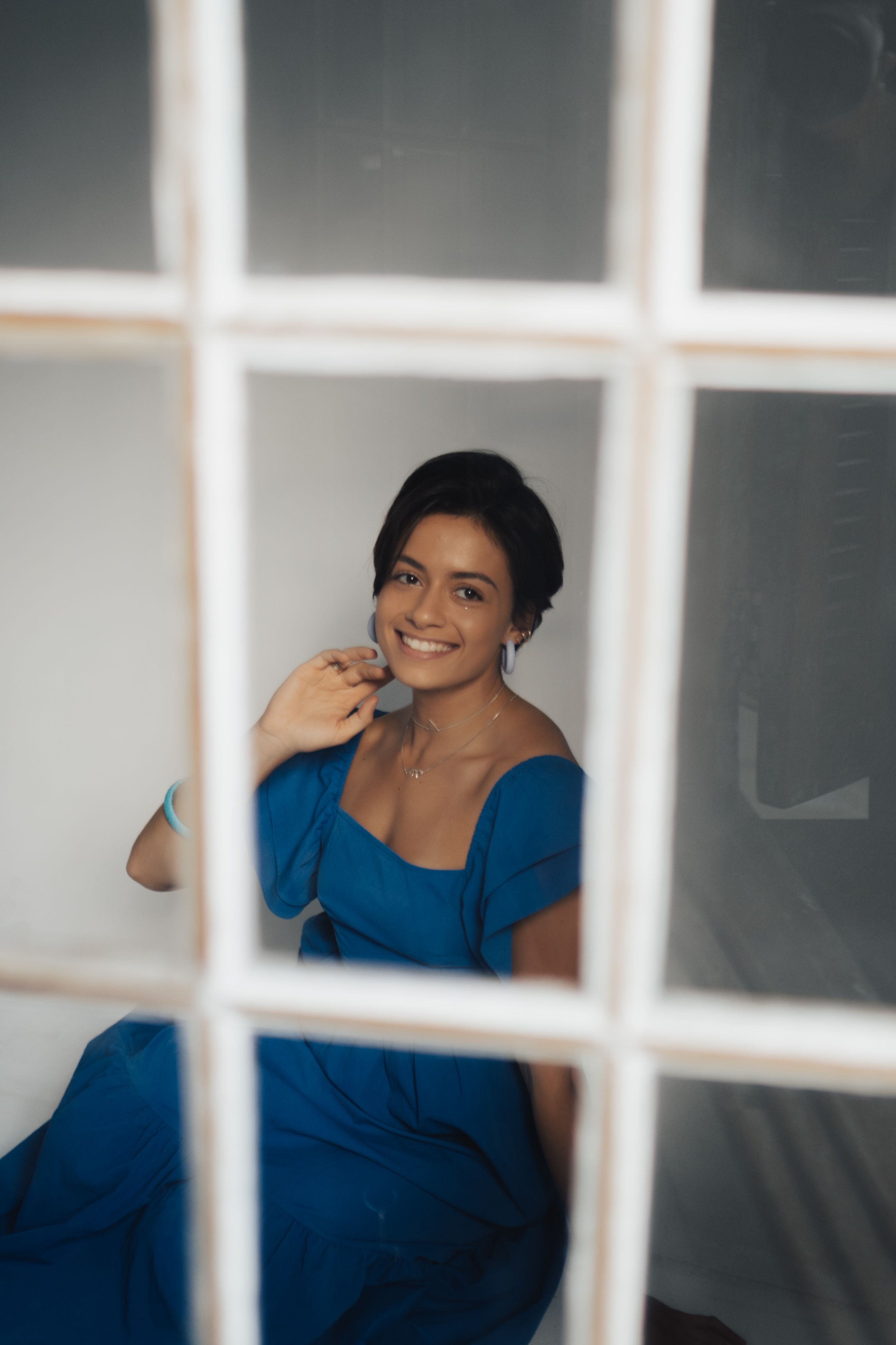 Smiling Woman behind the Window · Free Stock Photo
