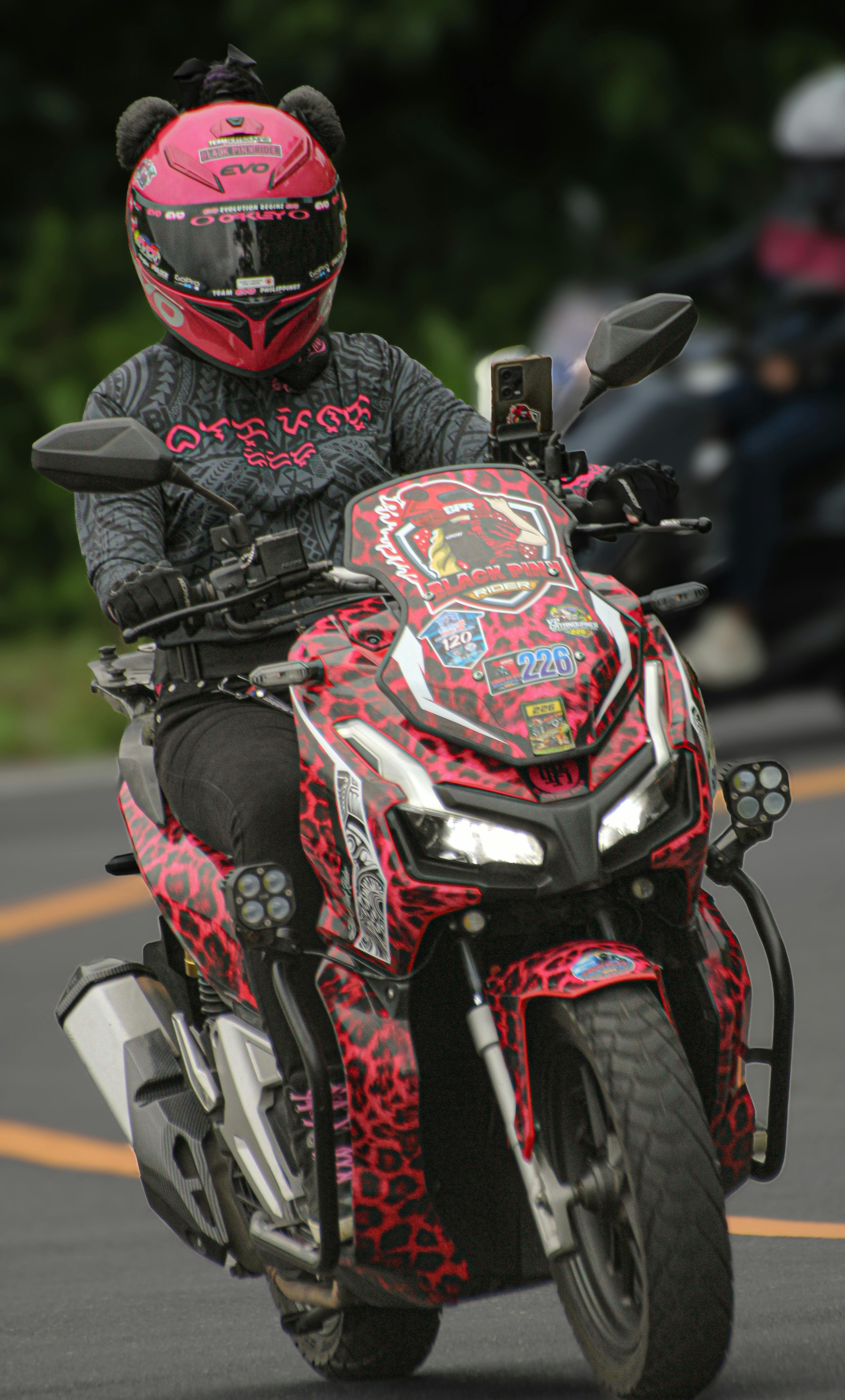 Person Riding on Yellow Motor Scooter on Road · Free Stock Photo