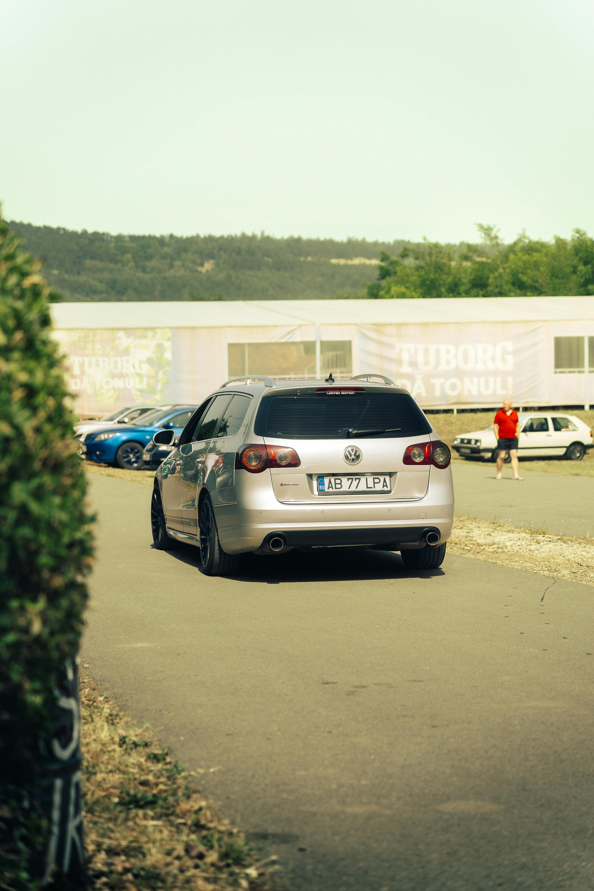 Silver VW Combi Car Driving on Parking Lot · Free Stock Photo