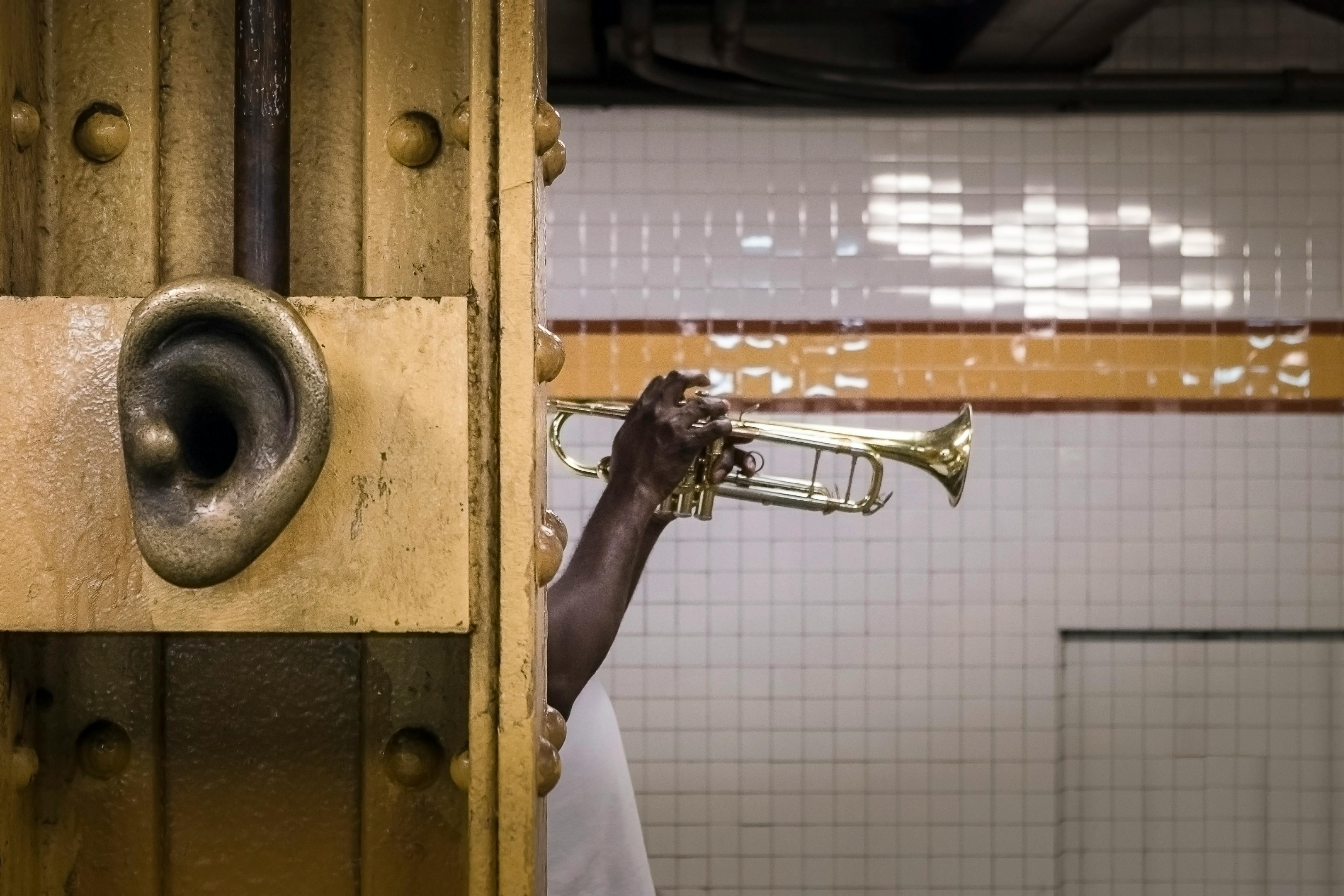 Man Playing Trumpet behind Wall · Free Stock Photo