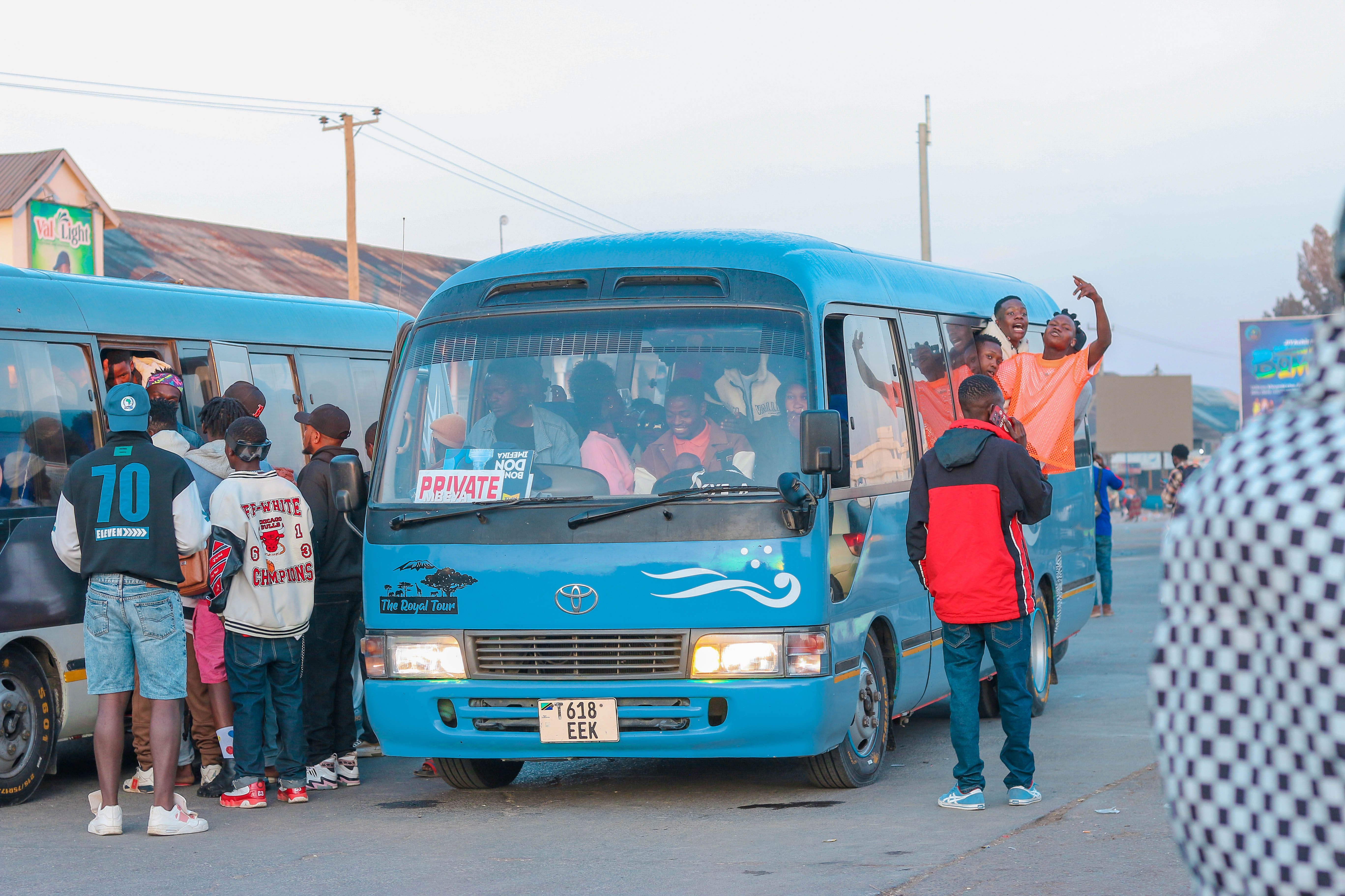 A group of people standing next to a bus · Free Stock Photo