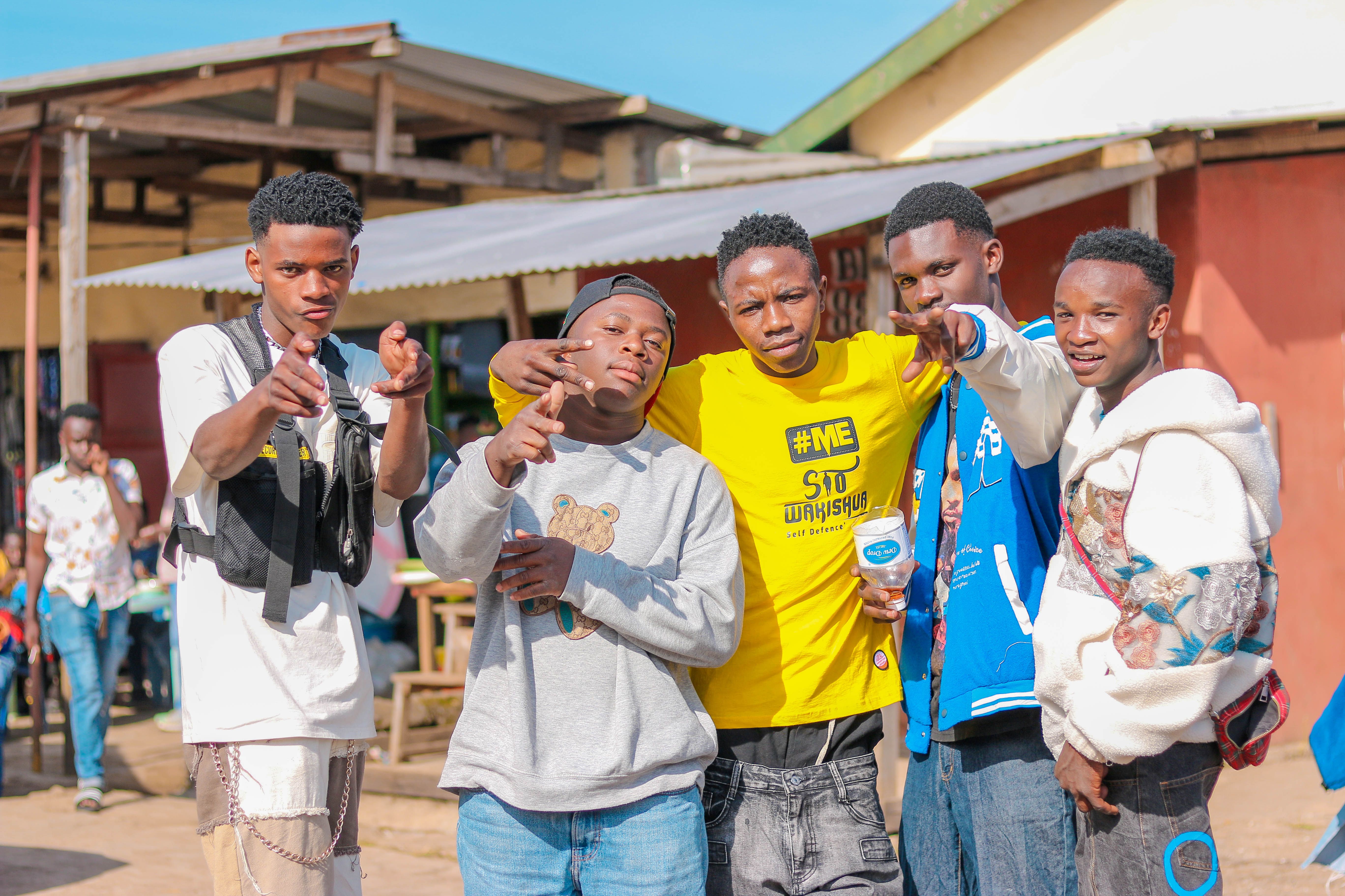 A group of young men standing in front of a building · Free Stock Photo