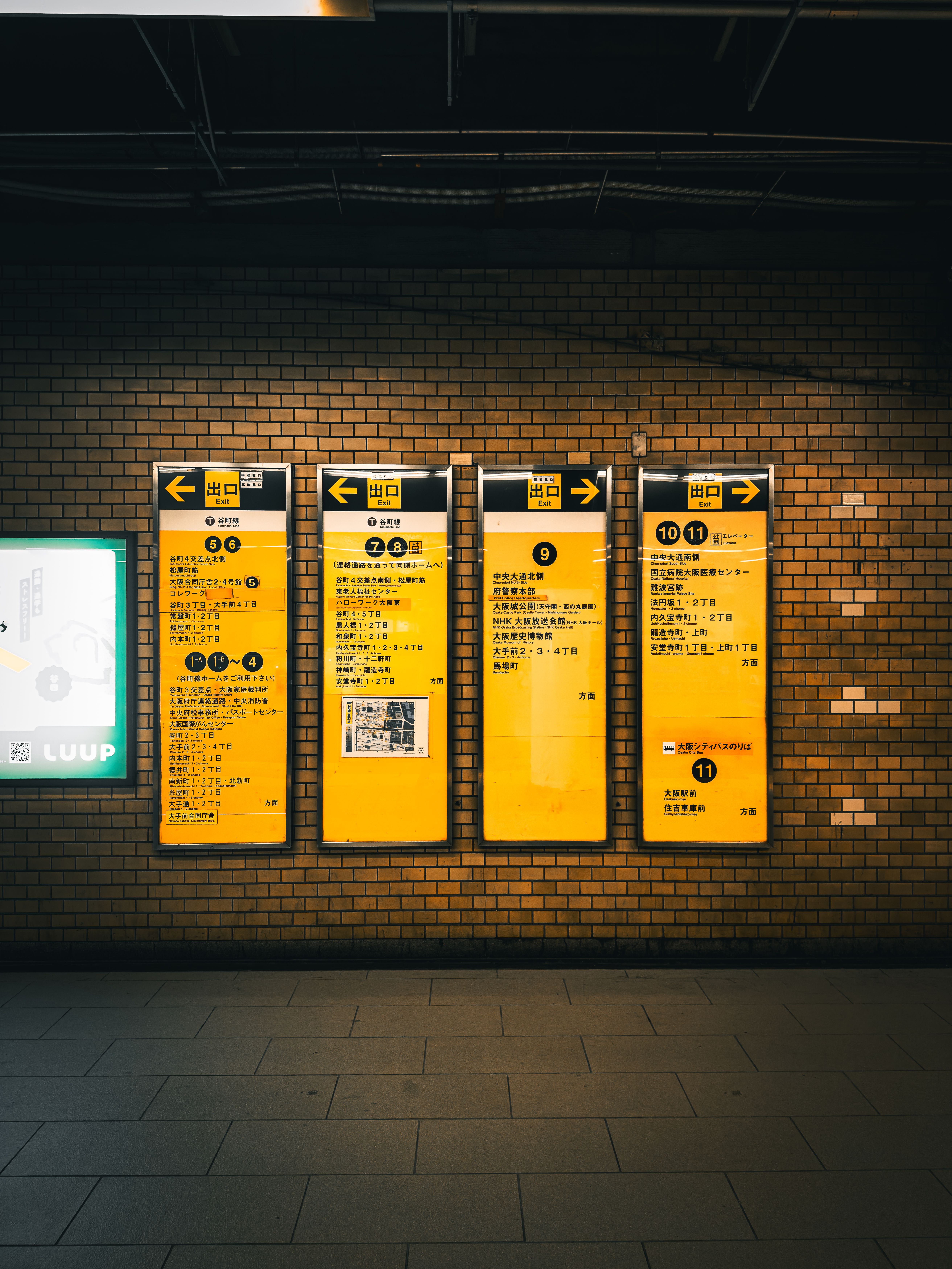 A subway station with yellow signs on the wall · Free Stock Photo
