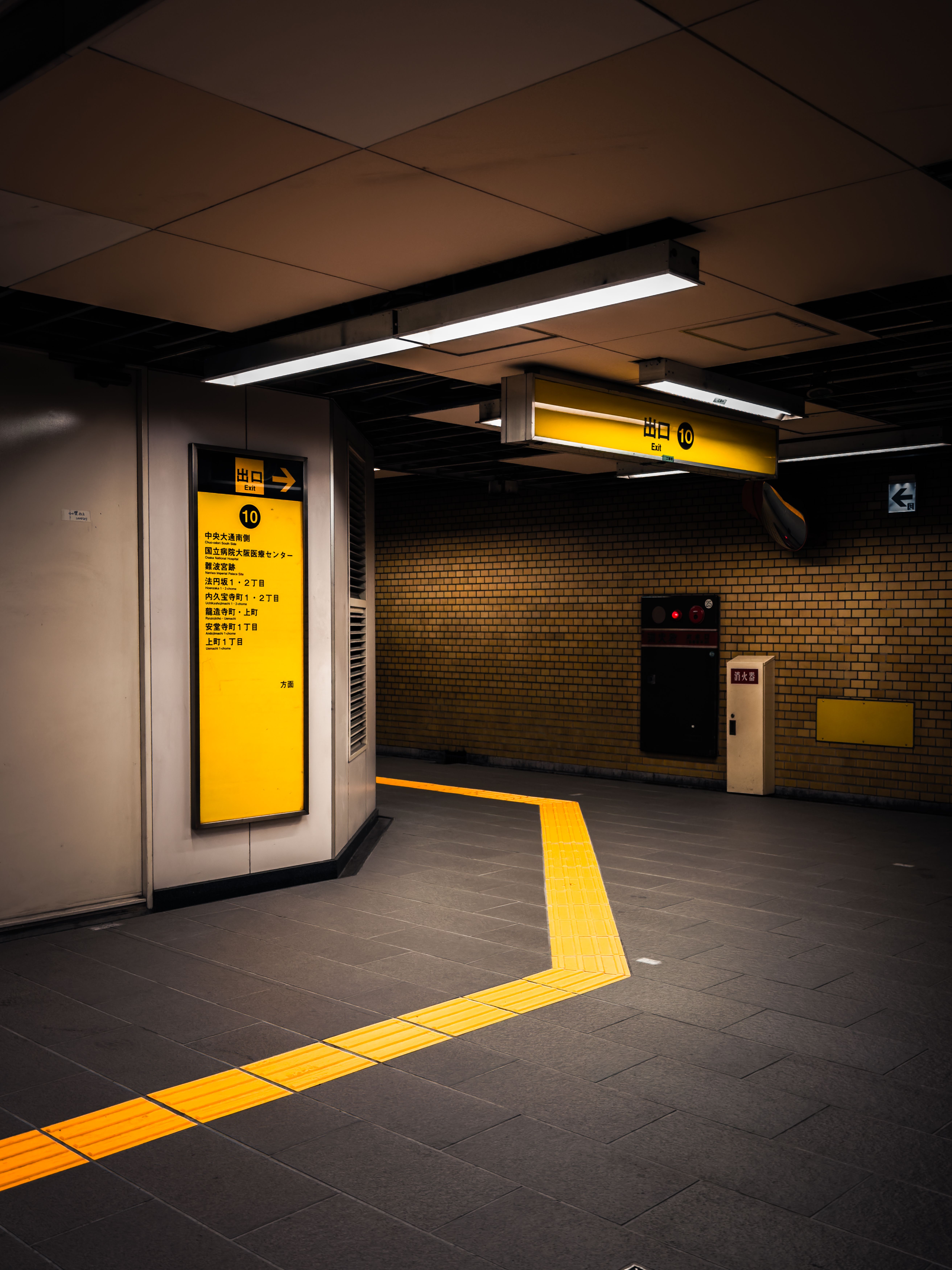 A subway station with yellow and black signs · Free Stock Photo