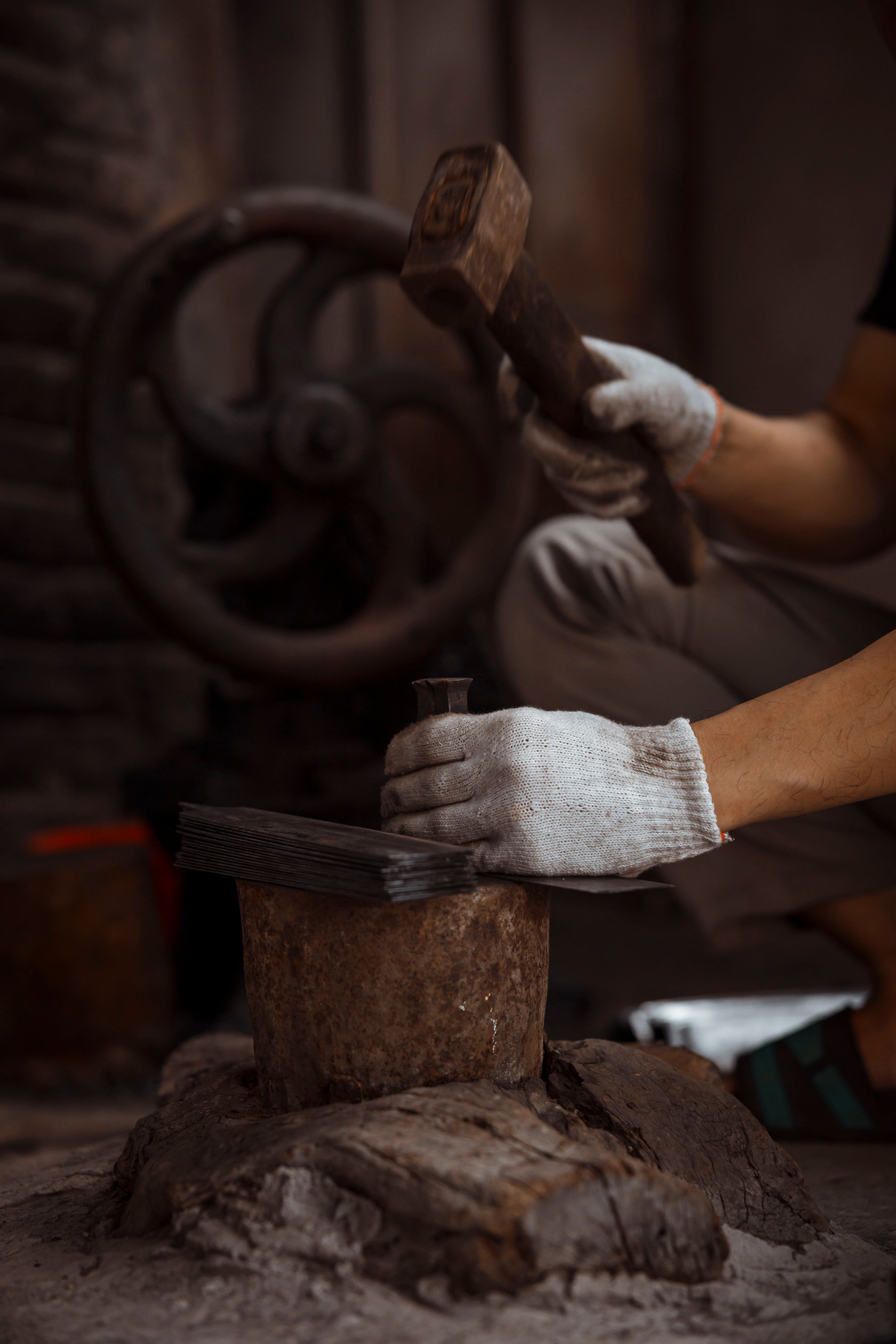 A person in gloves is working on a blacksmith · Free Stock Photo