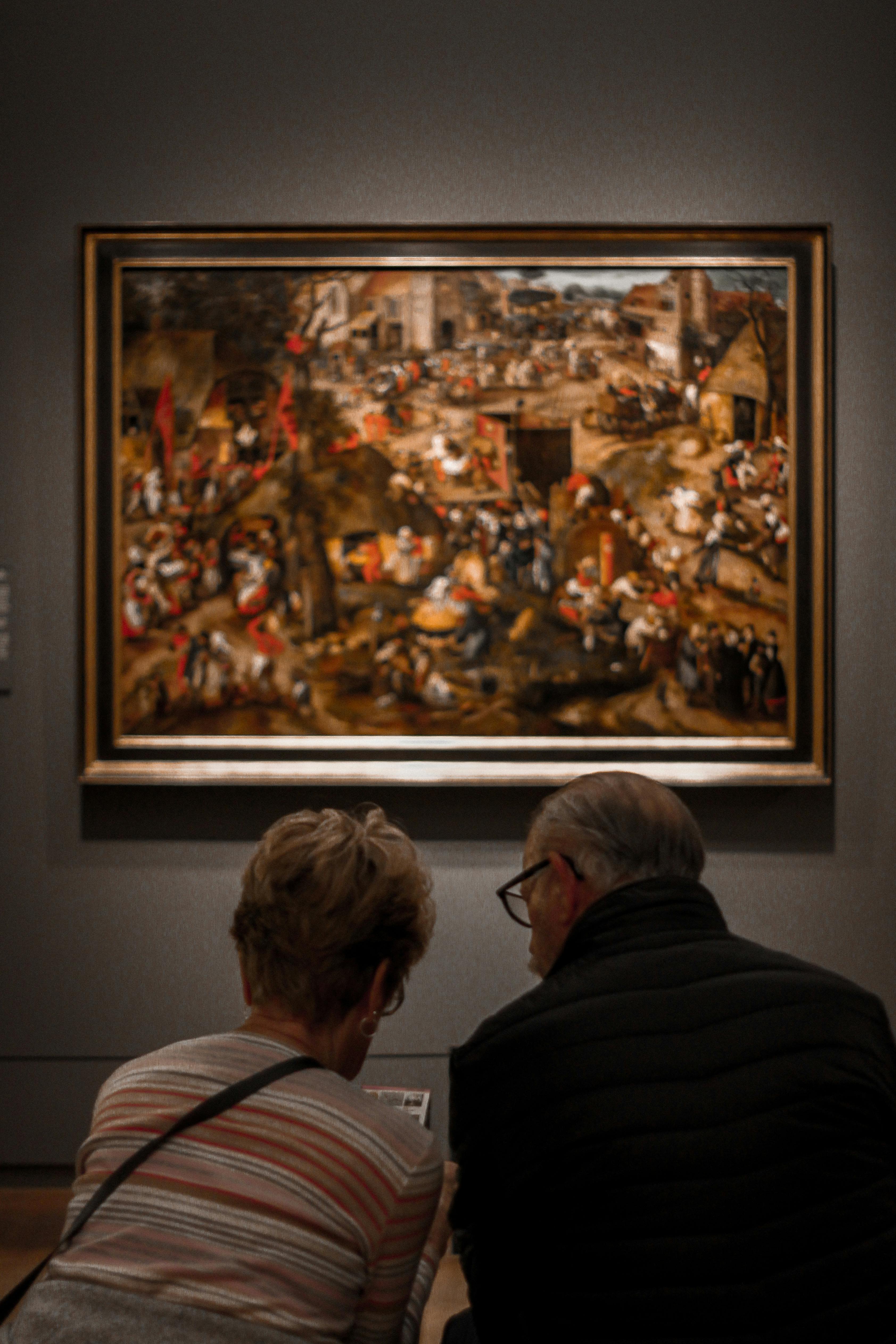 Two people looking at an art piece in a museum · Free Stock Photo