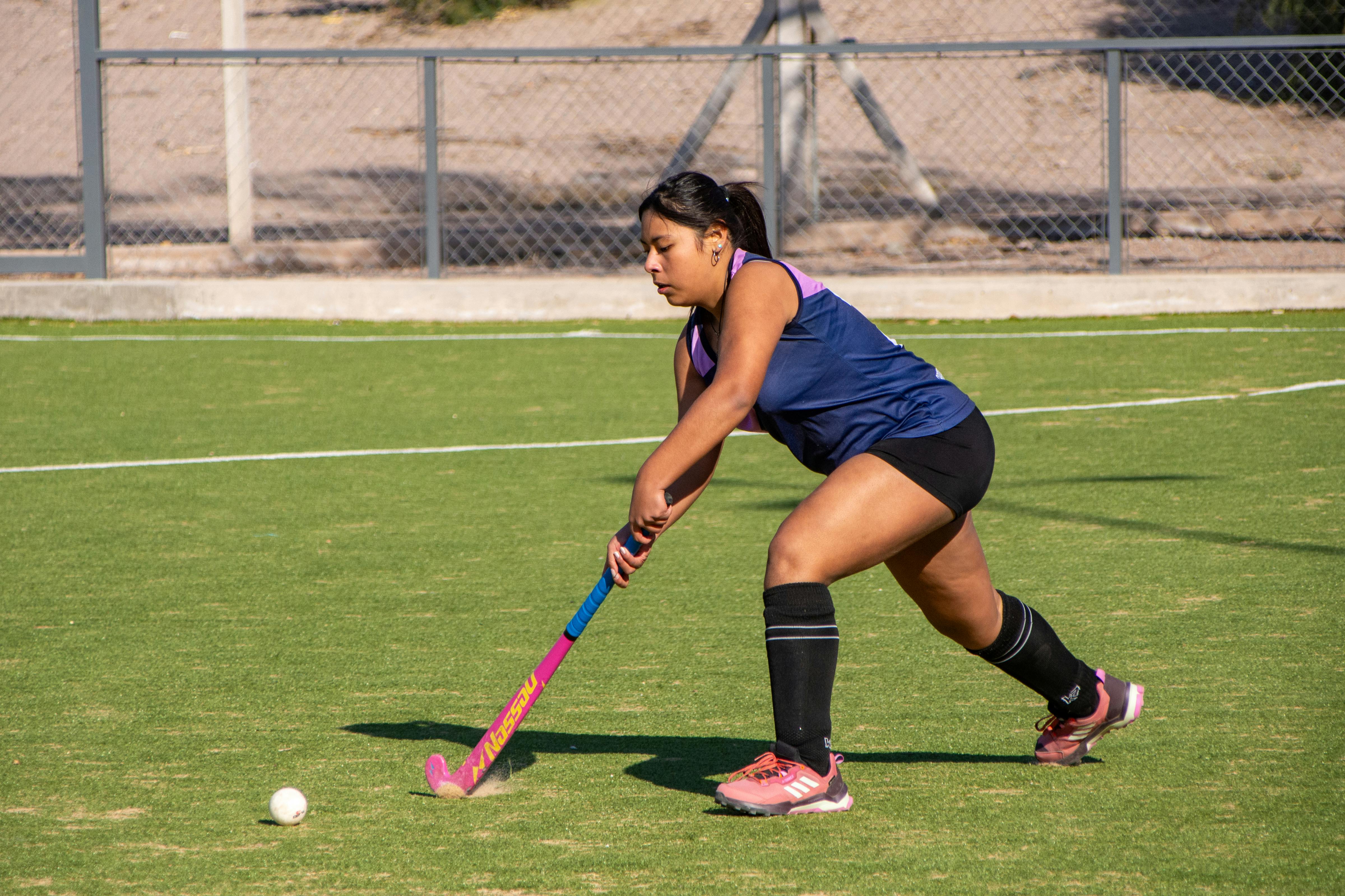A woman in blue and black playing field hockey · Free Stock Photo