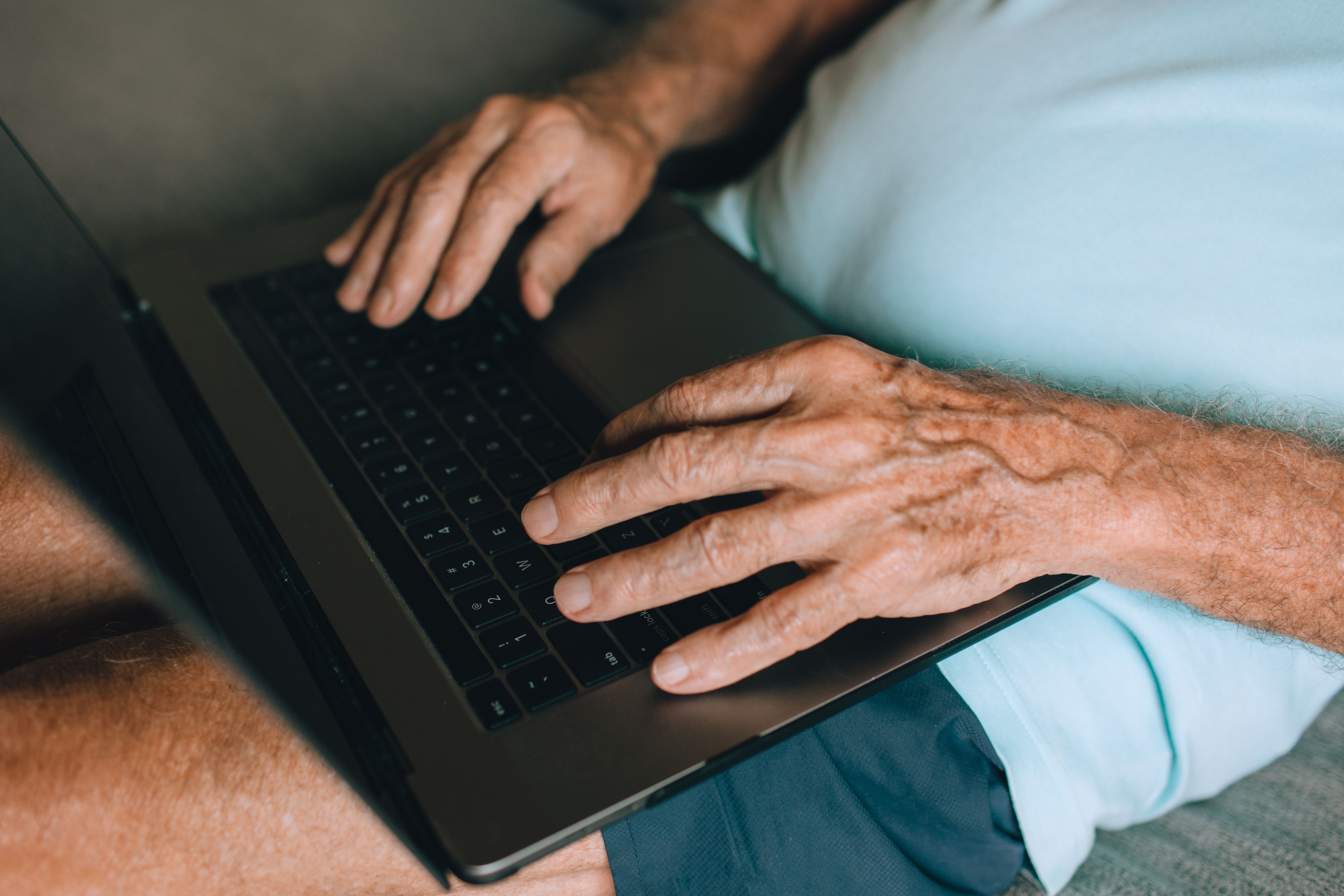 Hands of Elderly Man Typing on Laptop · Free Stock Photo
