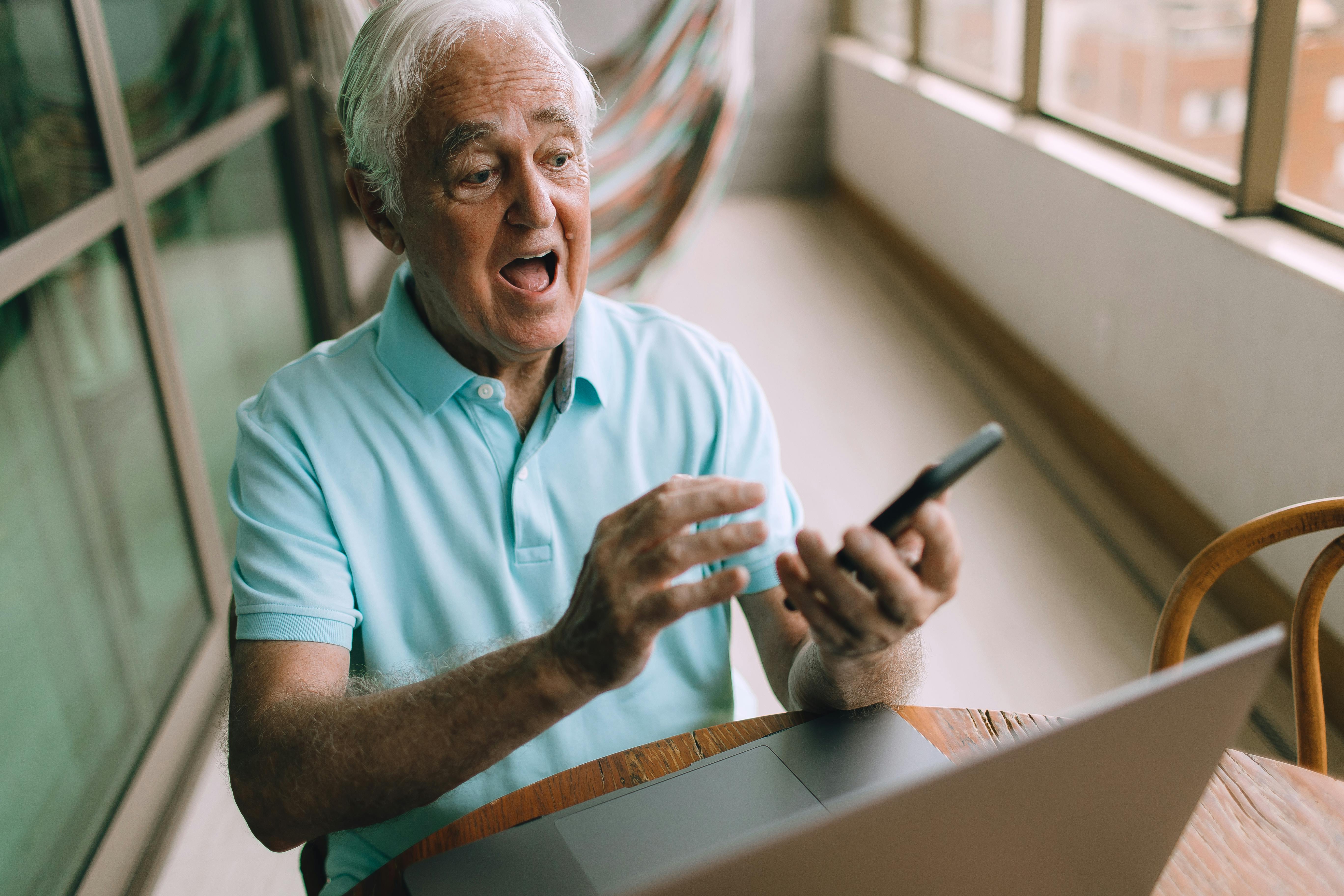 Elderly Man with Laptop and Smartphone · Free Stock Photo