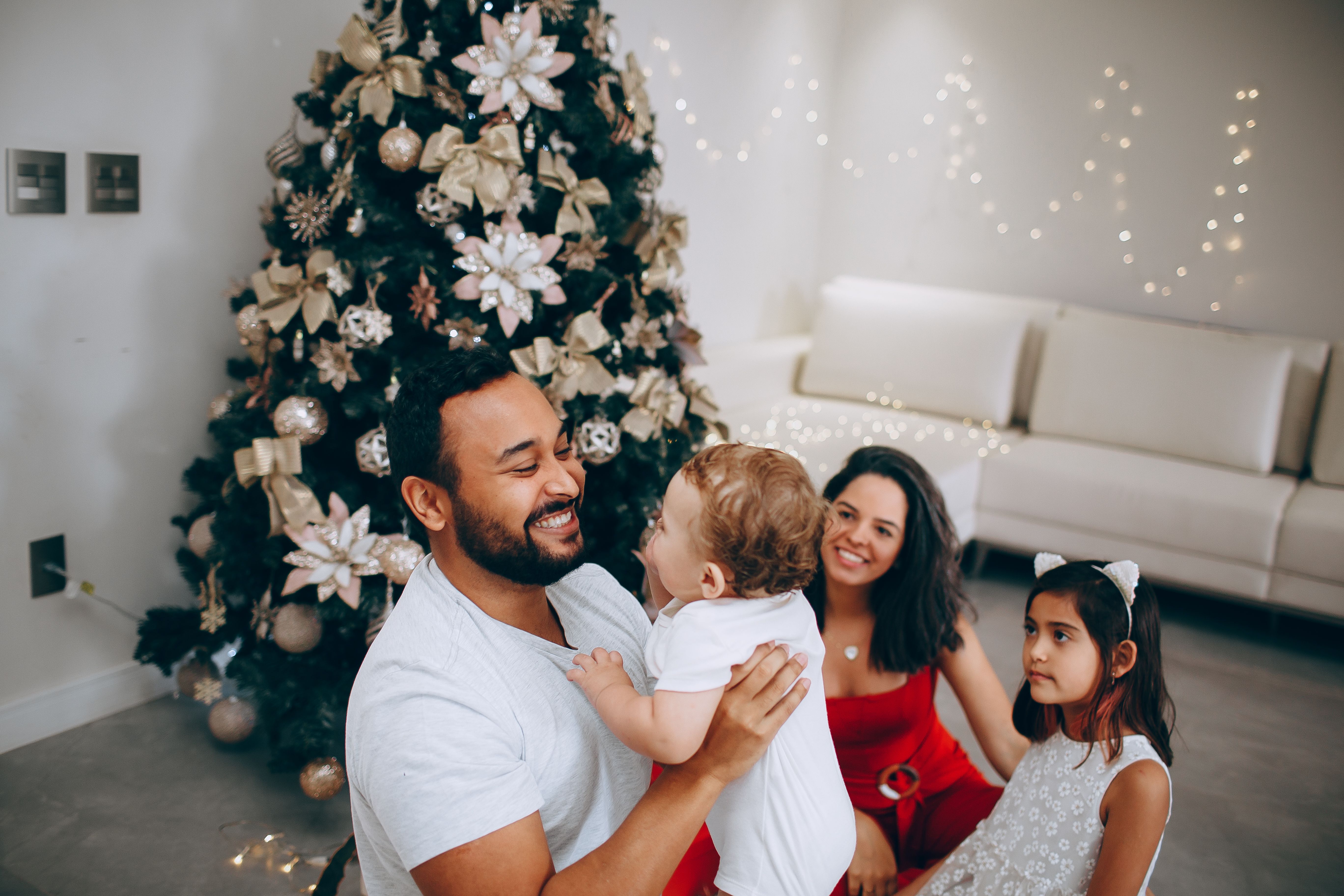 A Family Sitting by the Christmas Tree · Free Stock Photo